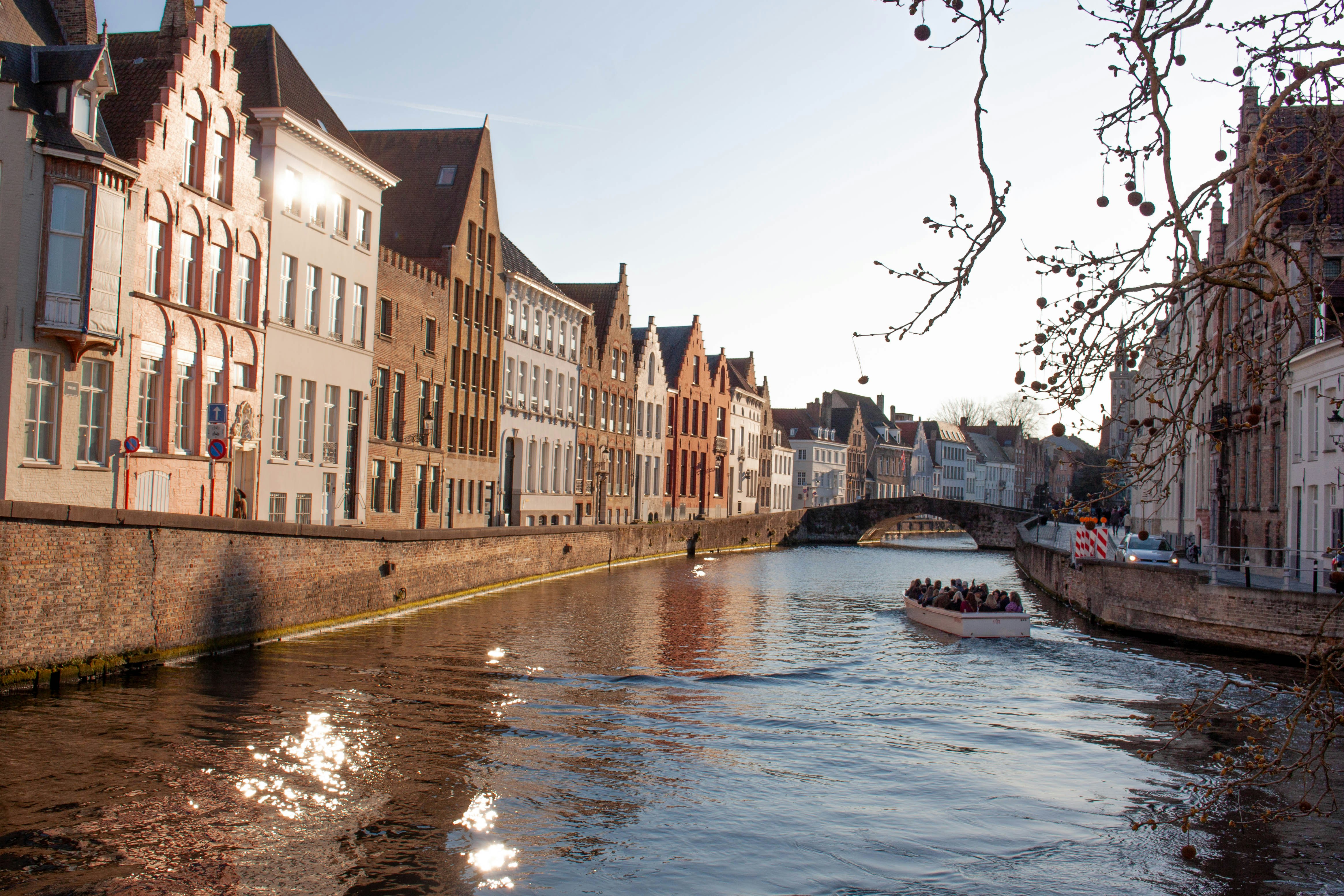 Sunlit Dutch Canal: Row of Gabled Townhouses Reflecting in Quiet Water