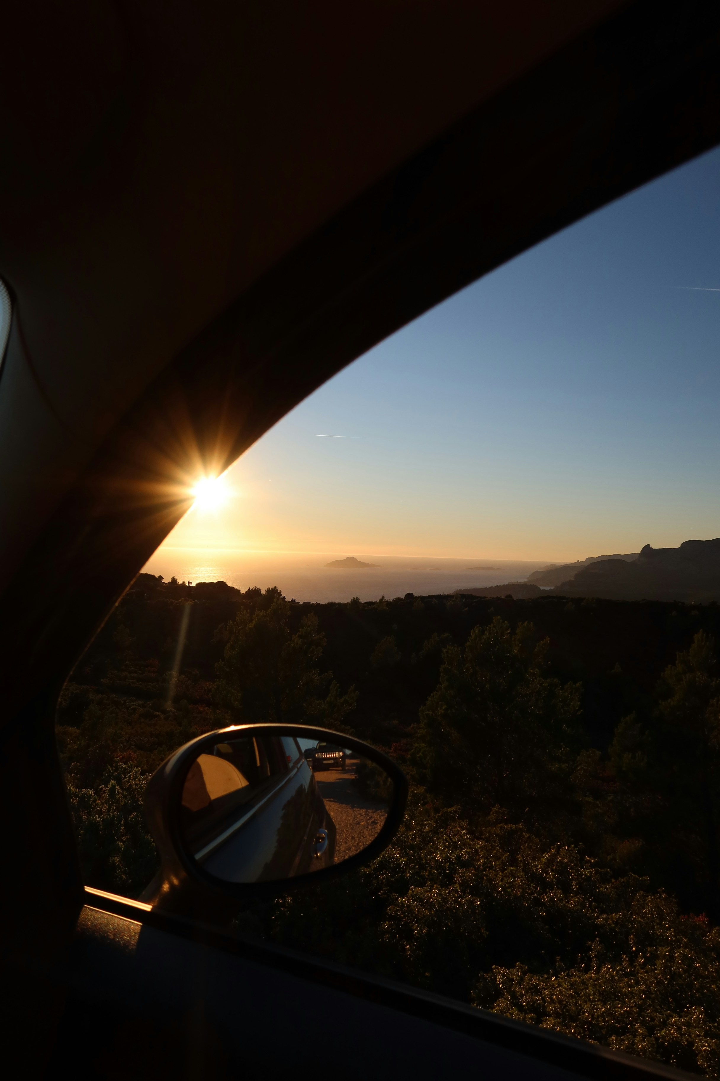 Sunlit Horizon through a Car Window Frame