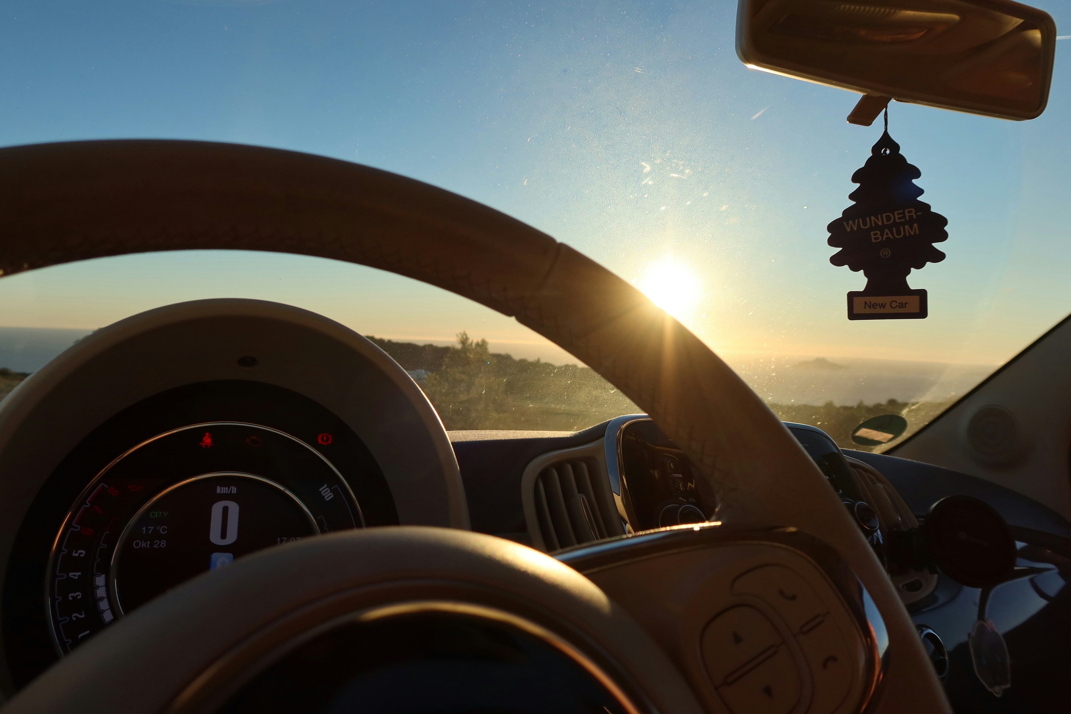 Sunlit Steering: A Car Interior at Dawn