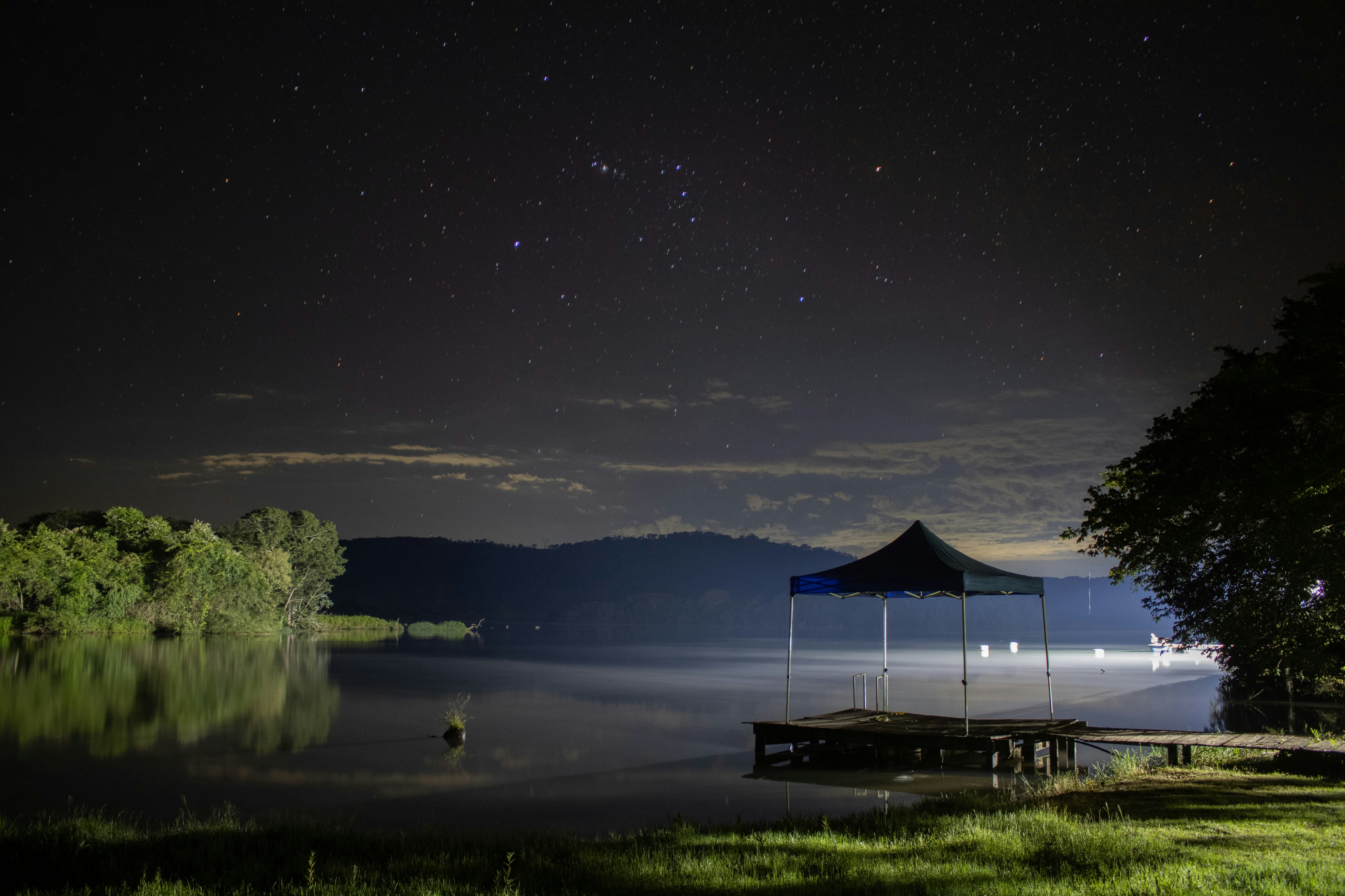 Moonlit Dock Beneath a Starfield