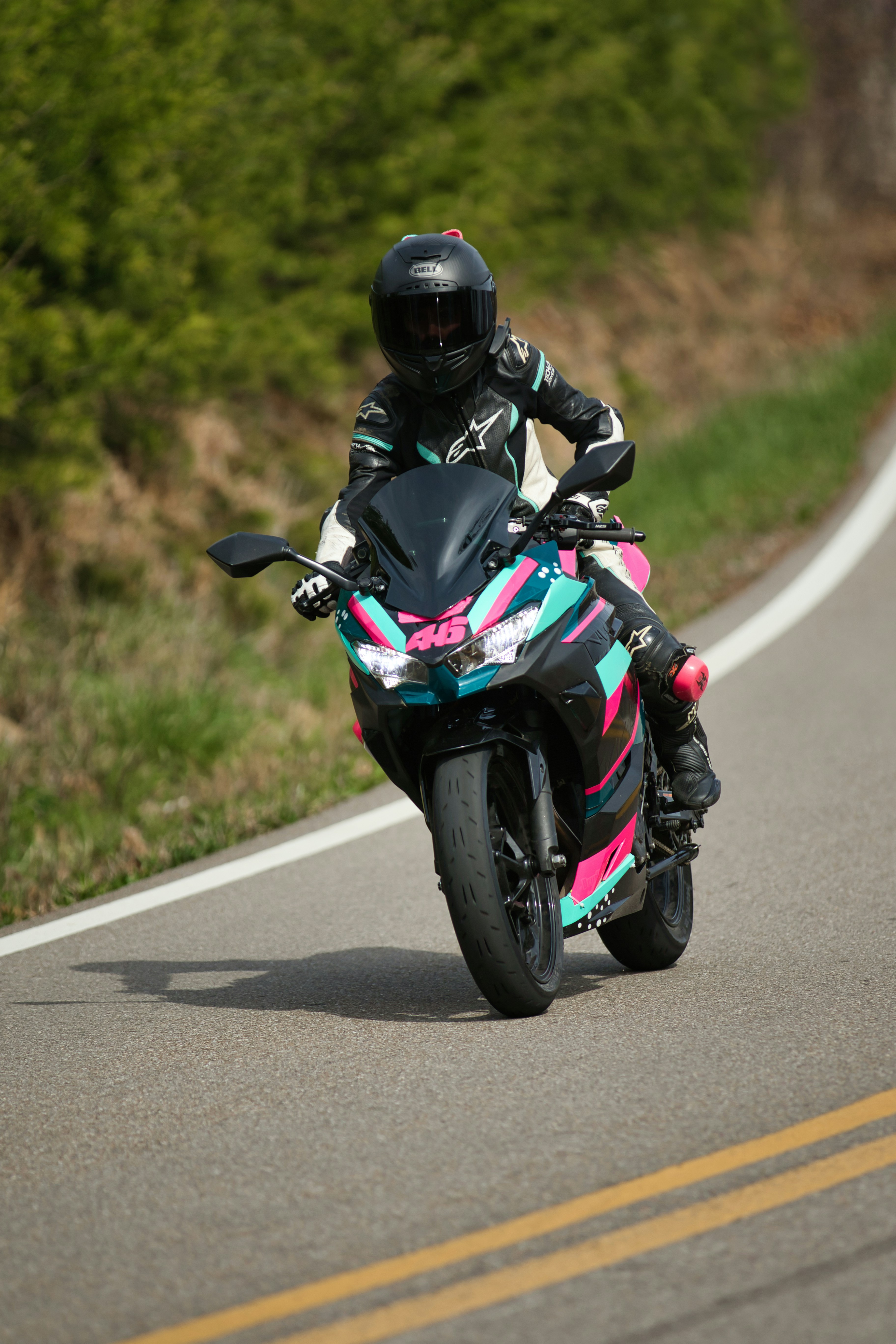 Neon-Trimmed Rider: A Dynamic Turn on a Quiet Road