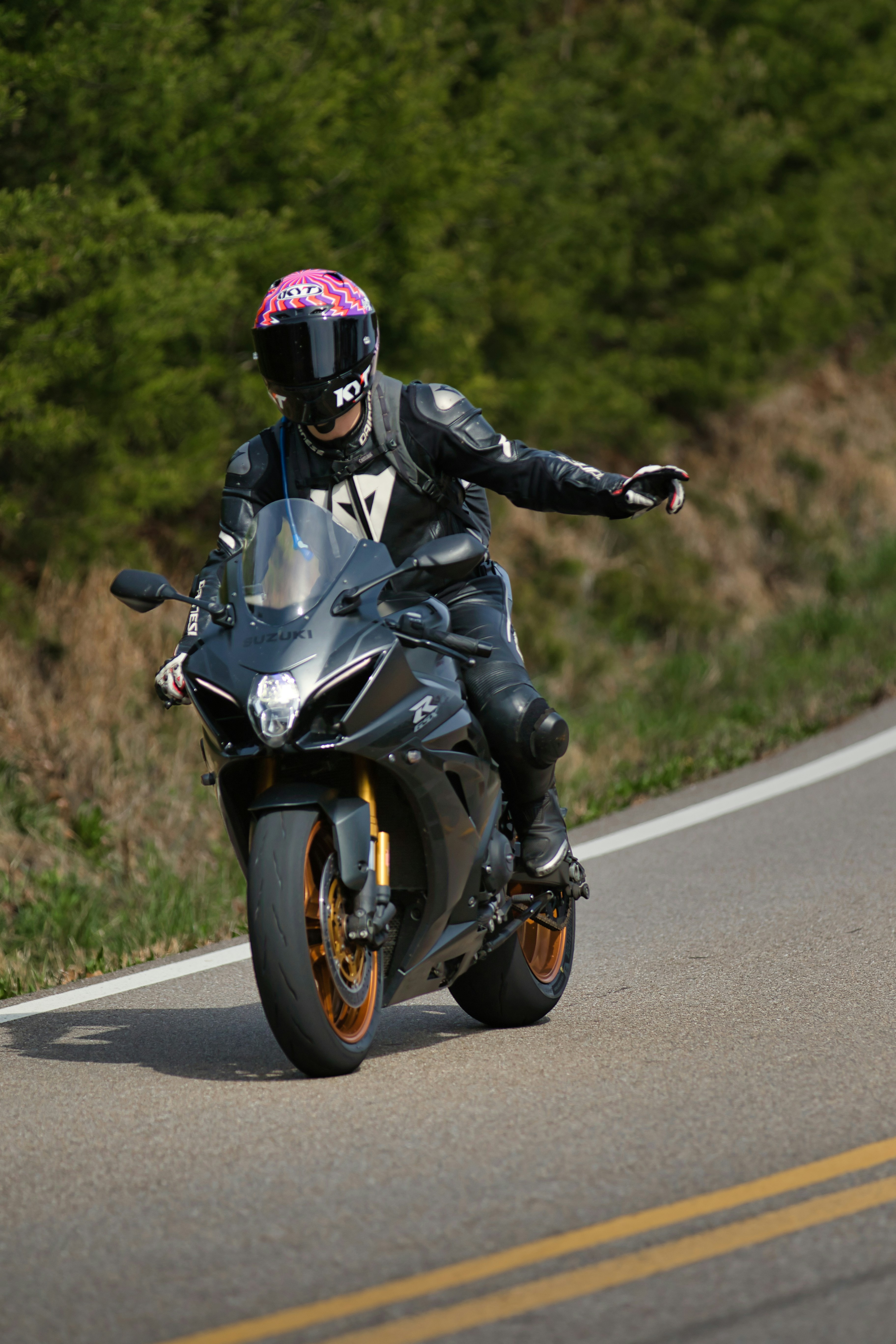 On the Edge: Rider Leaning Through a Curved Road