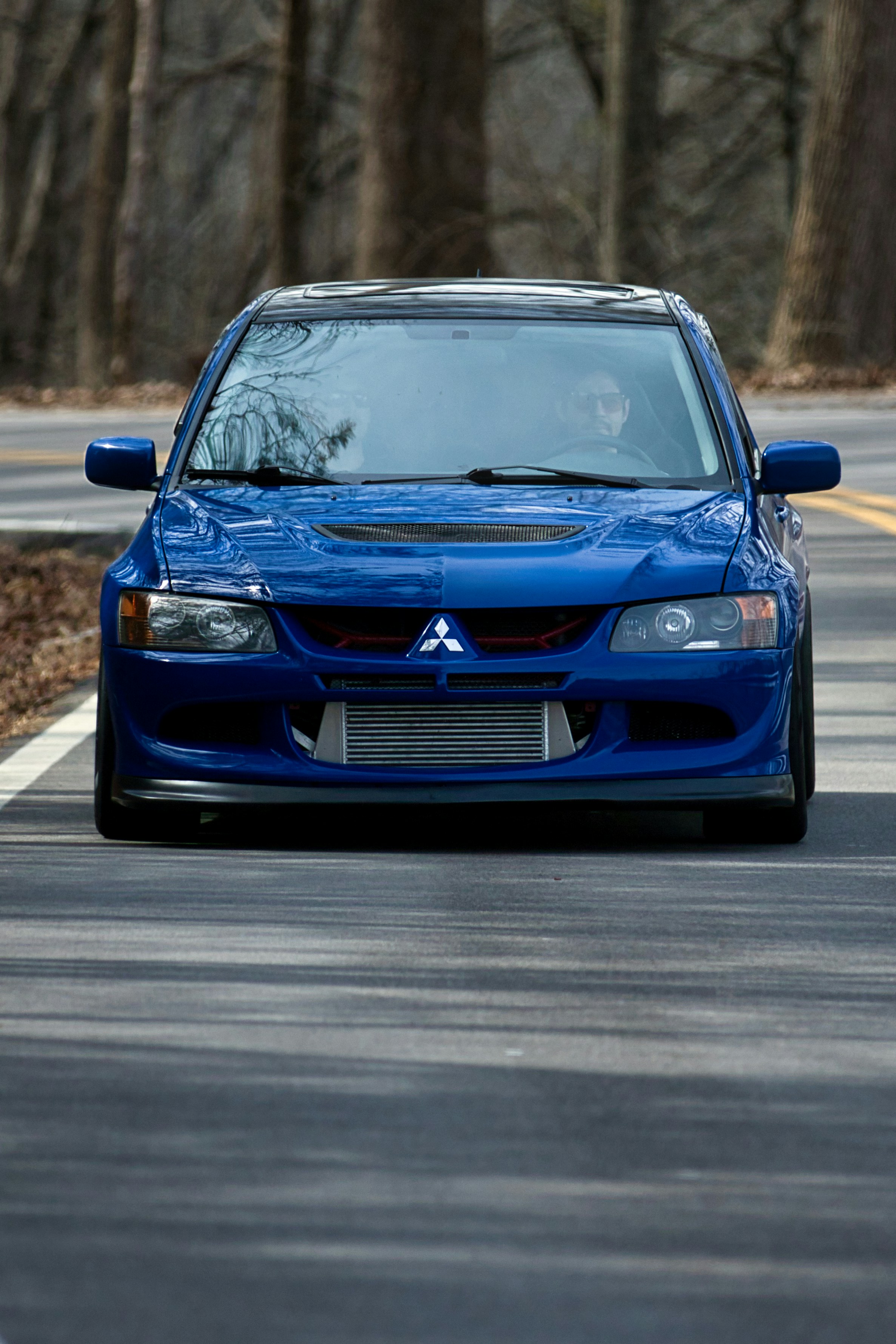Blue Mitsubishi Stature: Front-Focused Road Presence