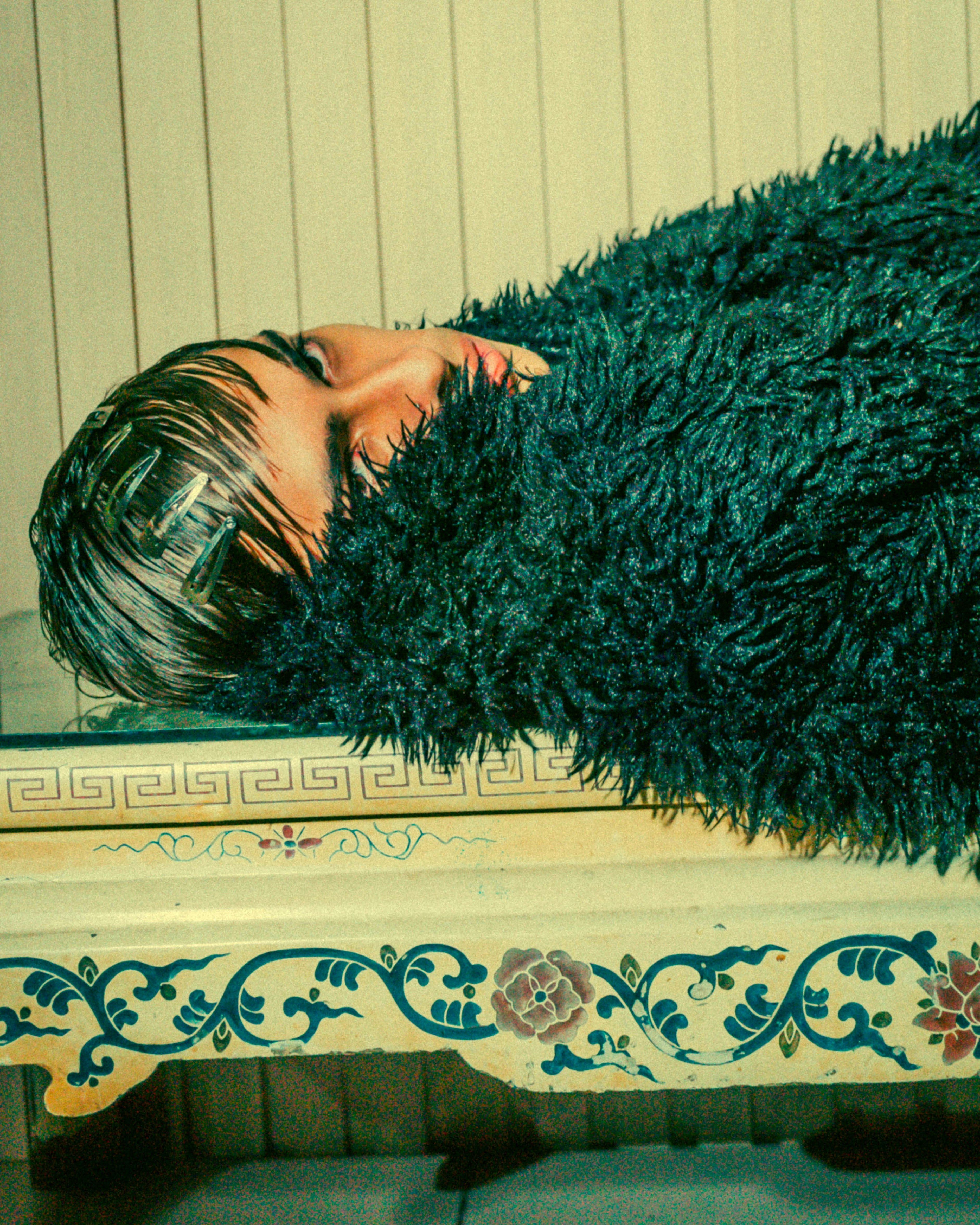 Emerald Cozy: a Trendy Portrait Resting on a Plush Black Fur