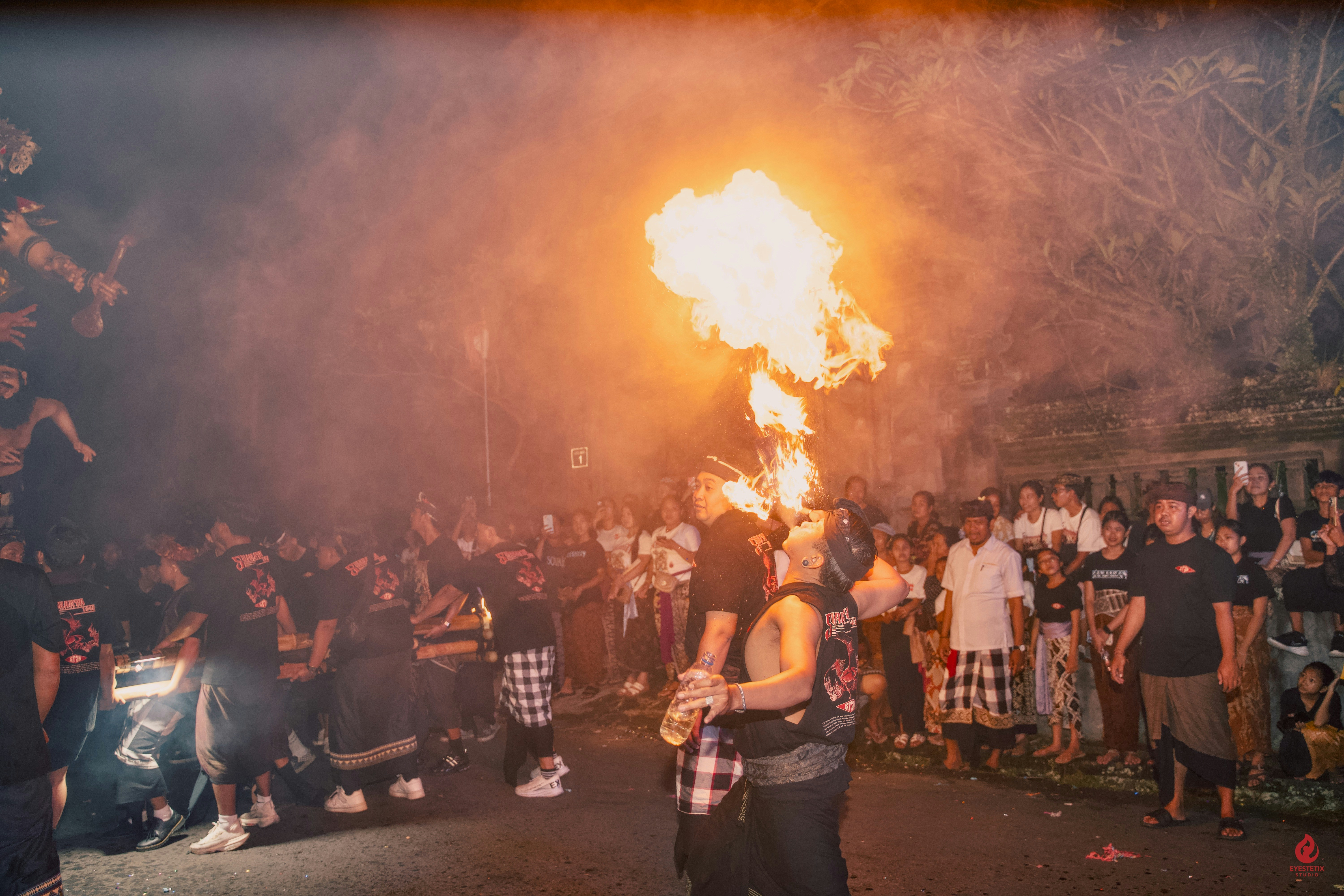 Fiery Stare: A Night of Torch Performance Amid a Watching Crowd