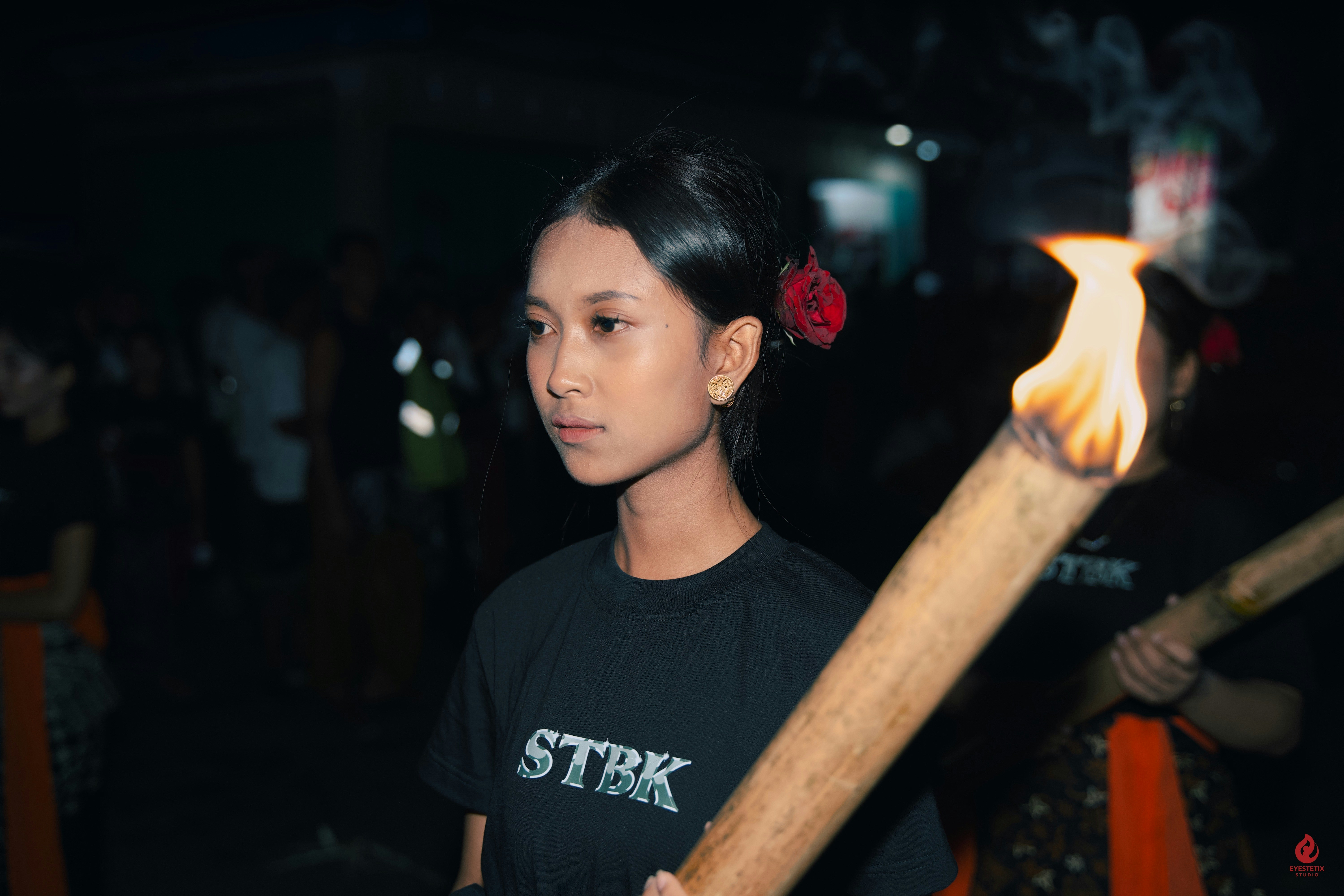 Quiet Resolve Under Fire: A Torchbearer Leads the Night