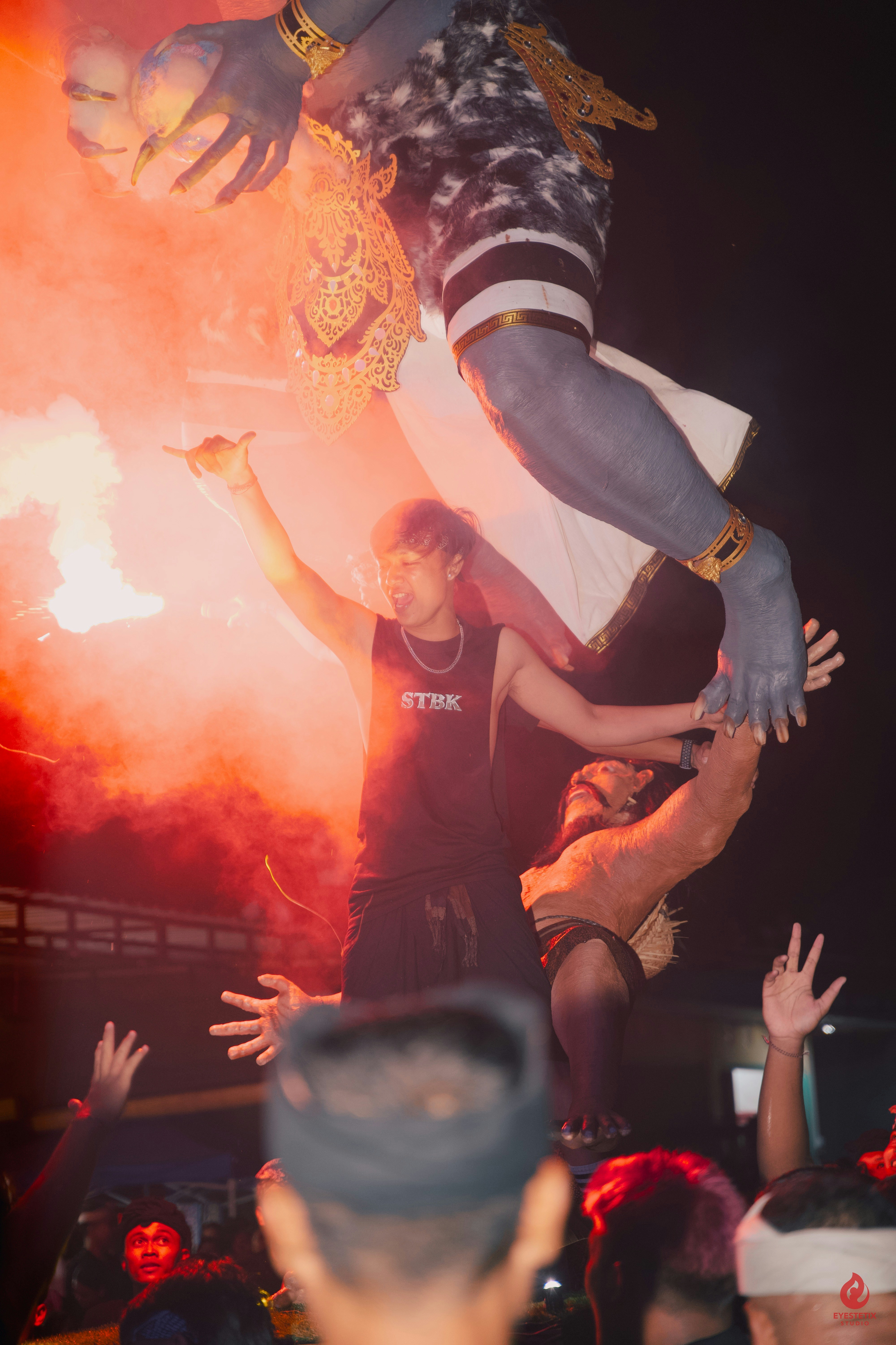 Crowd Surges Under a Floating Giant: Dancers and Fire in a Night Festival