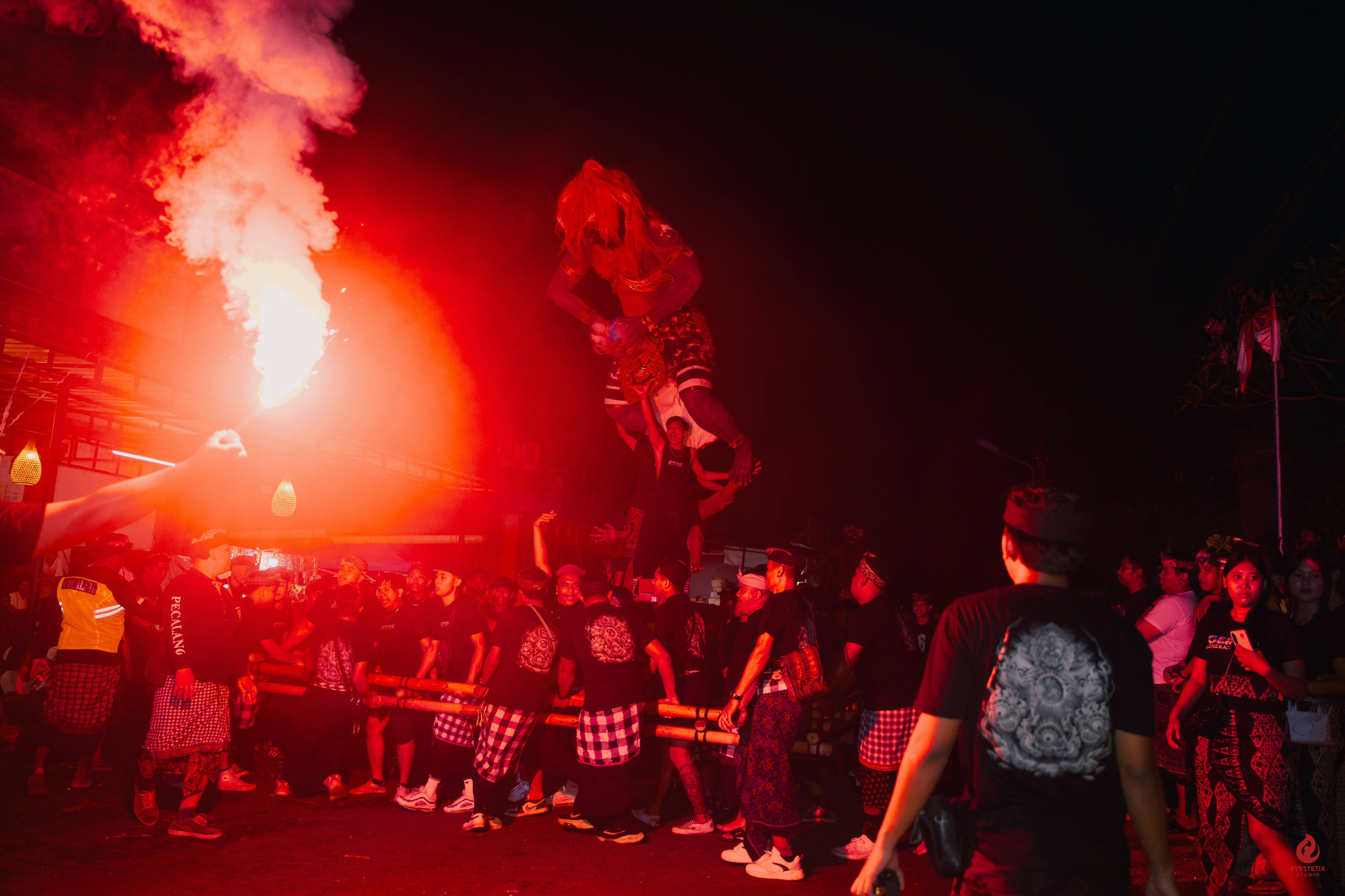 Midnight Fury: A Crowd Surges Beneath a Flaming Signal