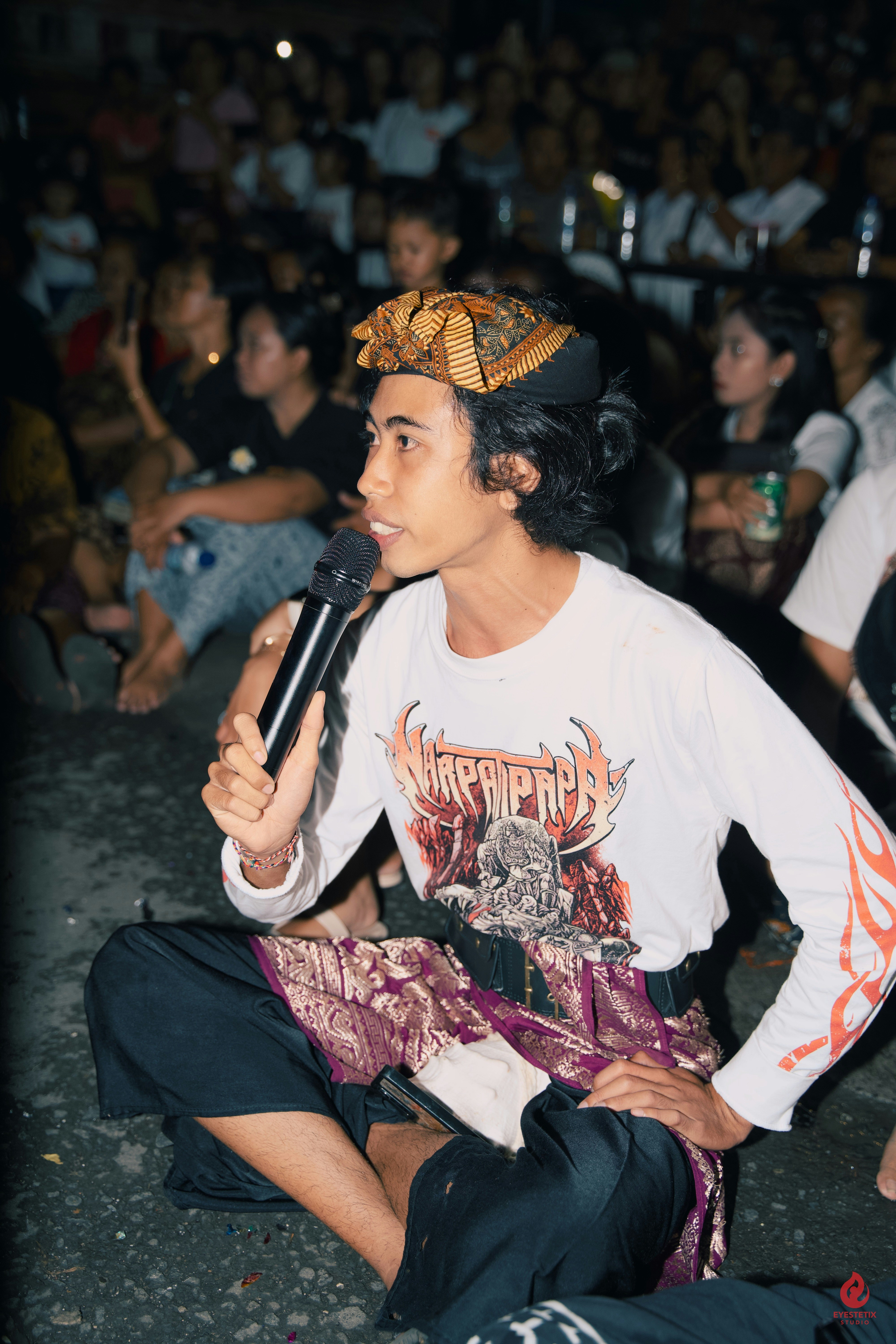 Microphone in Hand, Spotlight on the Performer in a Night Crowd