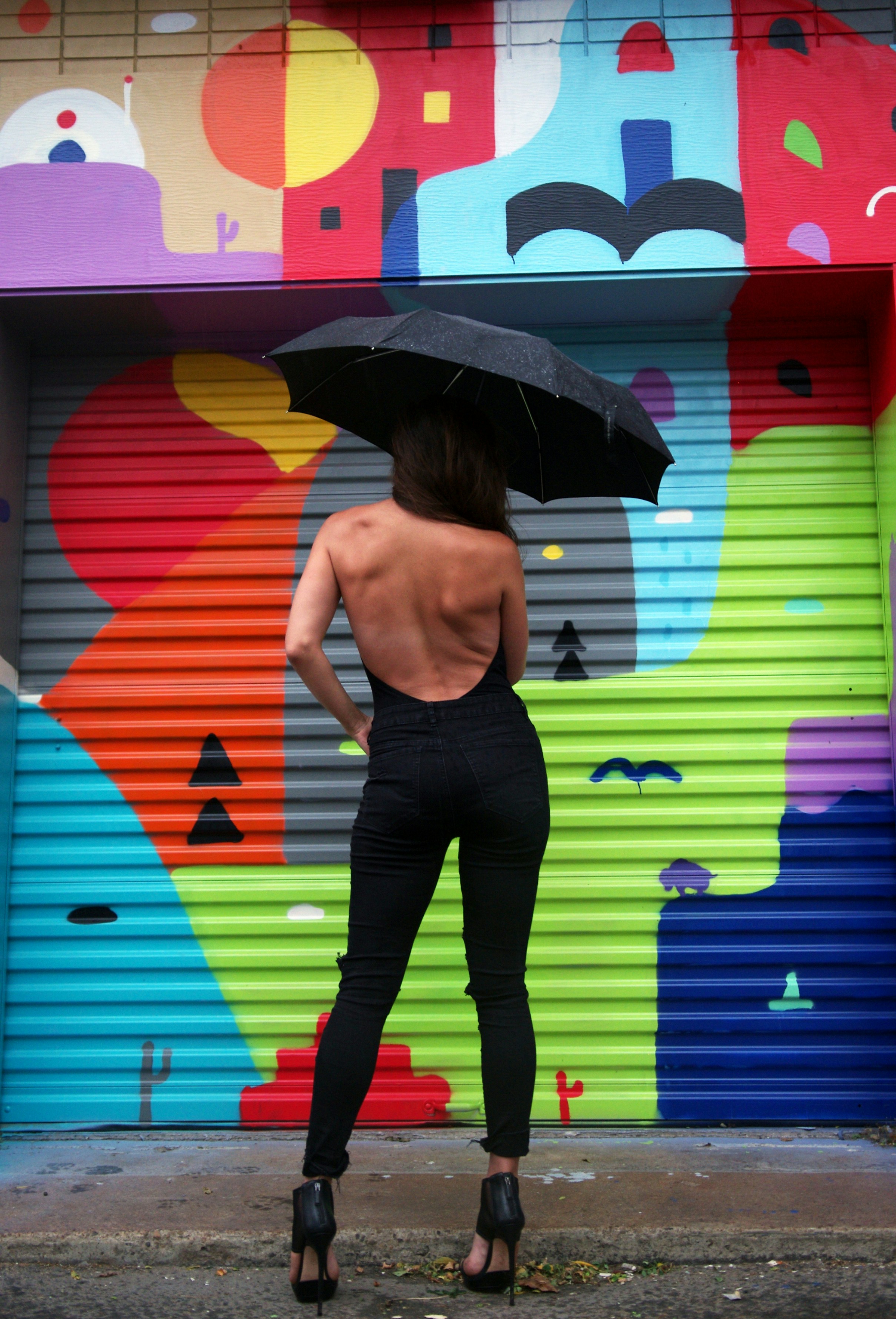 Midnight in Color: Backlit Portrait Before a Graffiti Wall