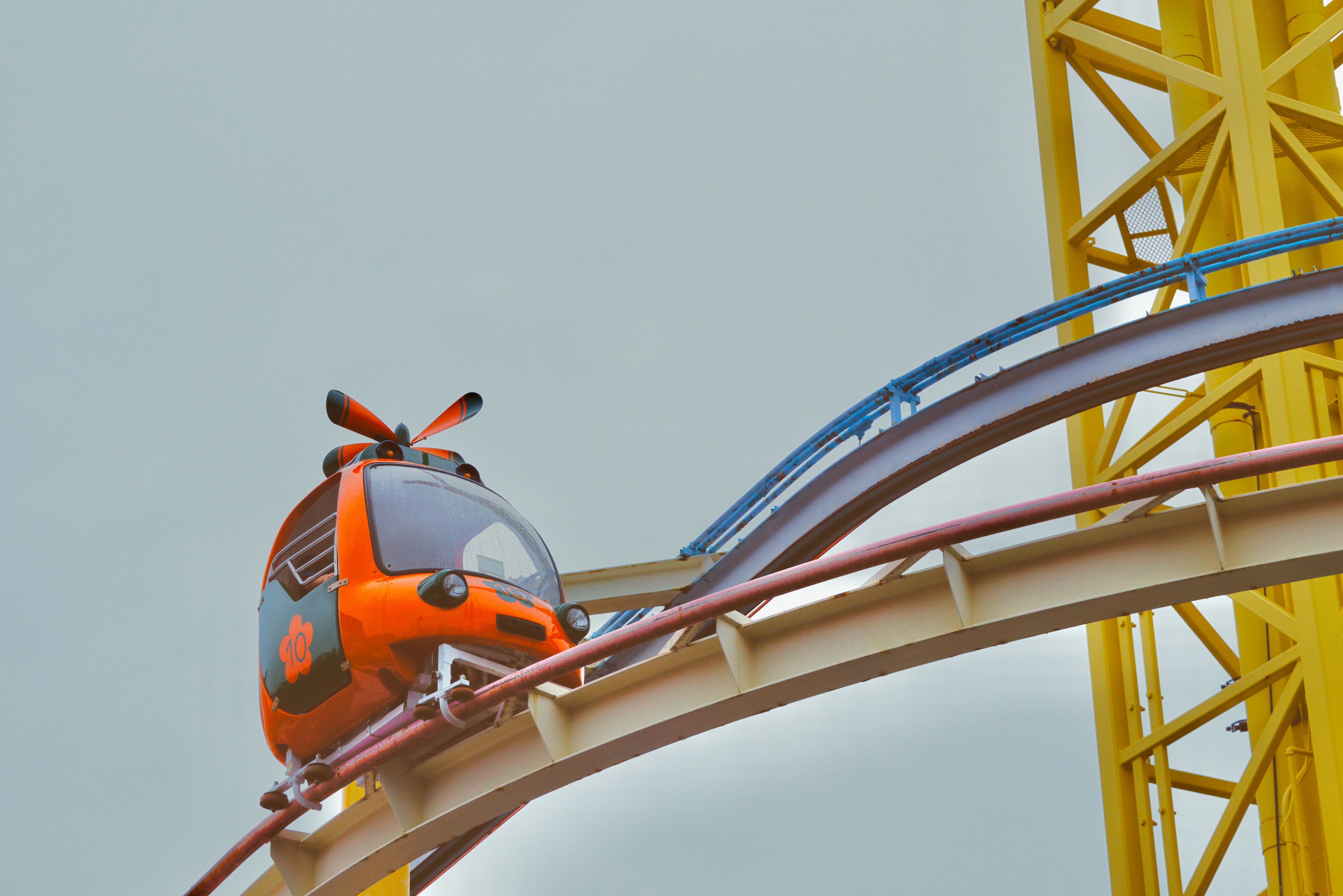 Orange Rotorcraft on a Curved Steel Path