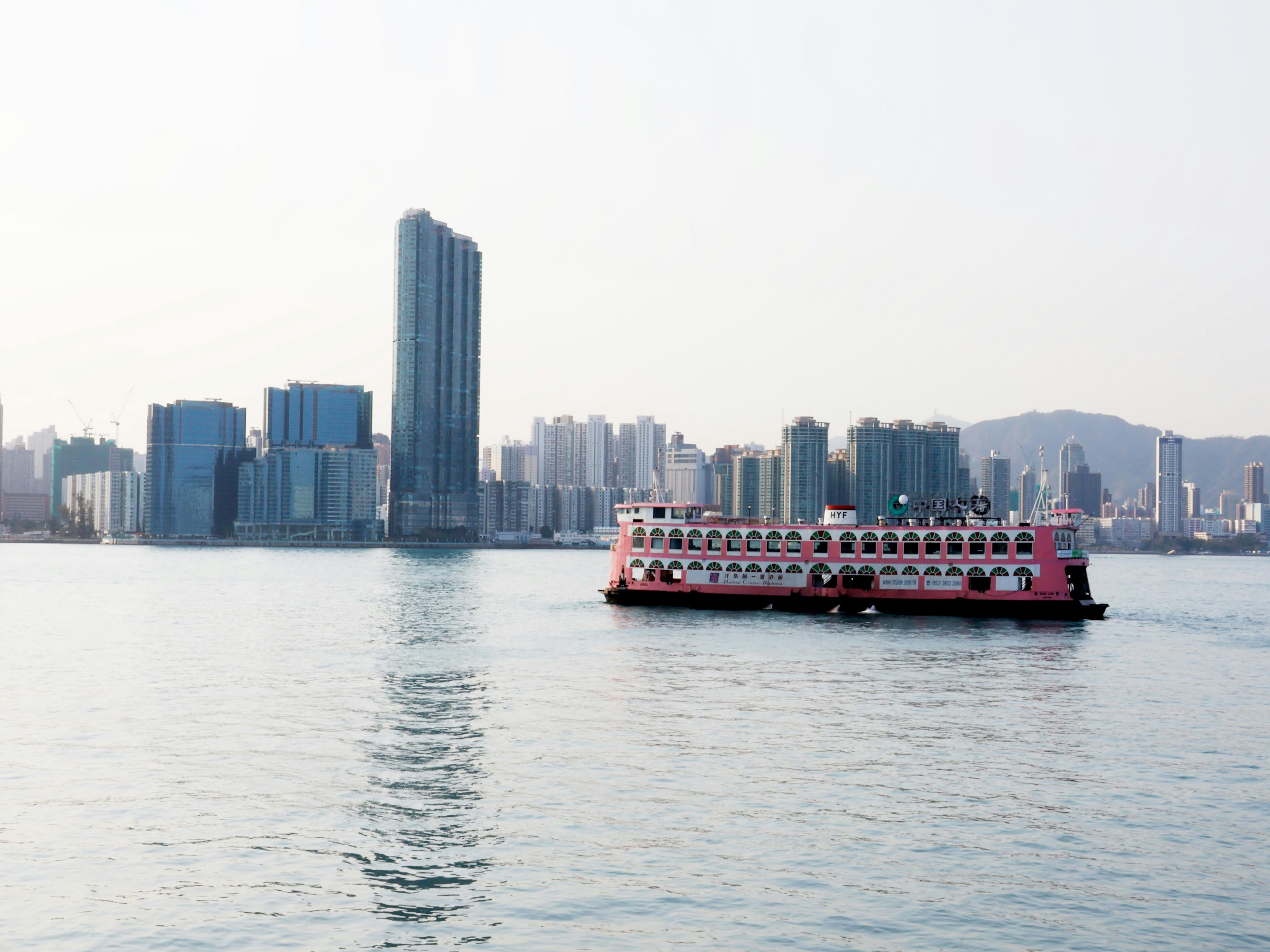 City Harbor Ferry Quietly Traverses a Neon Skyline