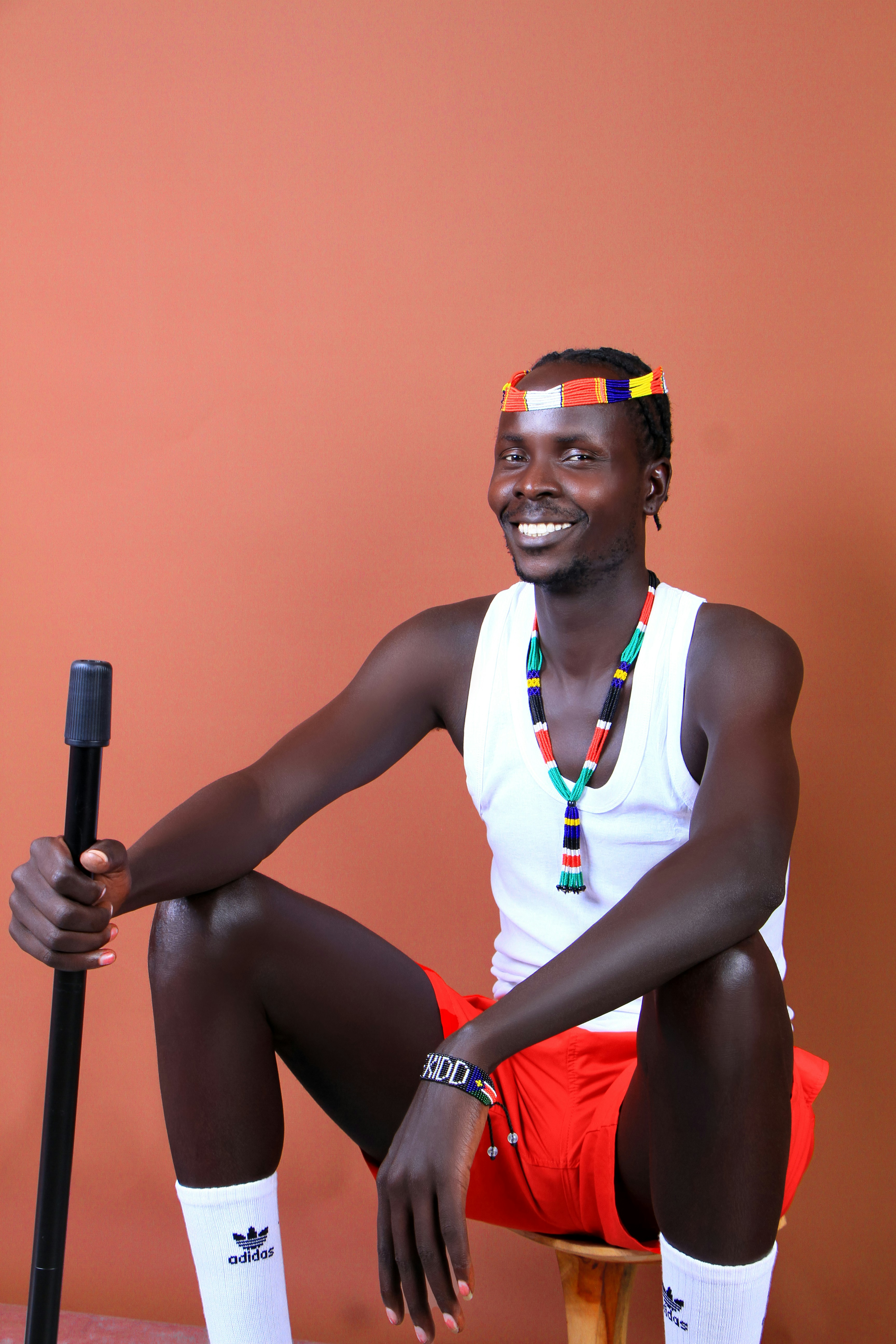 Joyful Power: A Lively Portrait in Bold Orange Backdrop