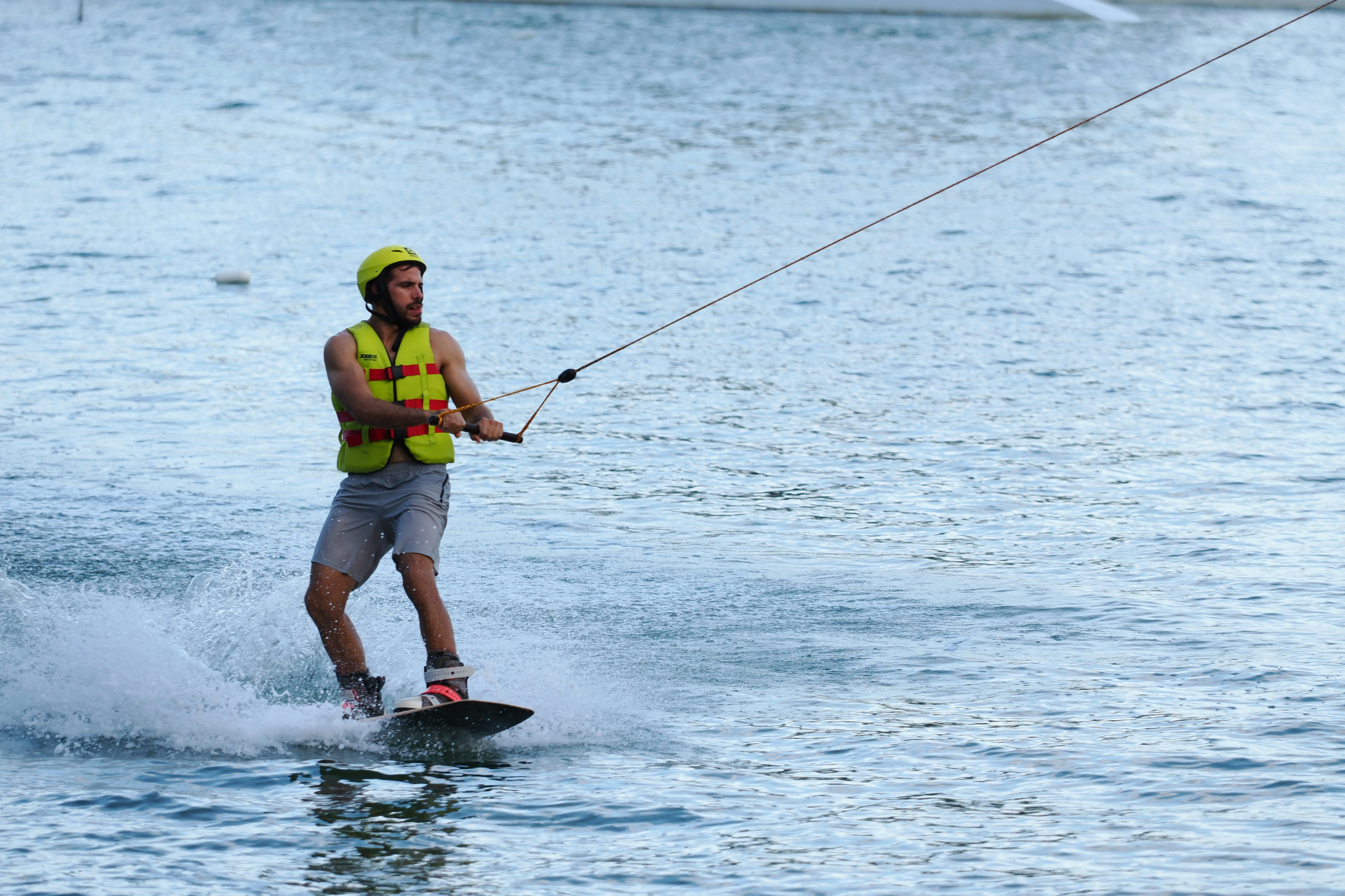 Waterbound Rider: Harnessing Tension and Spray on a Wakeboard