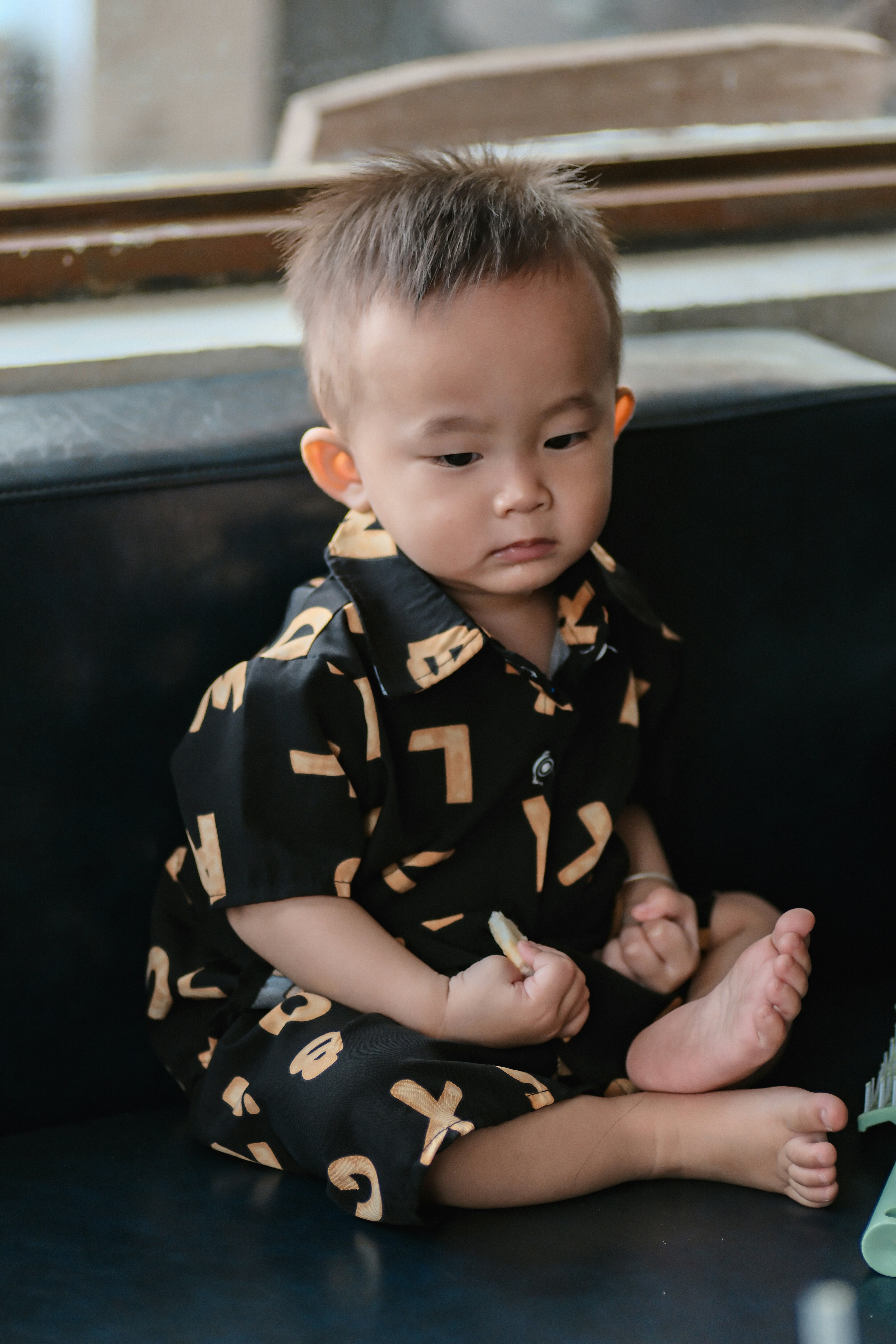 Quiet Curiousness: A Young Explorer in Dark Geometric Pajamas