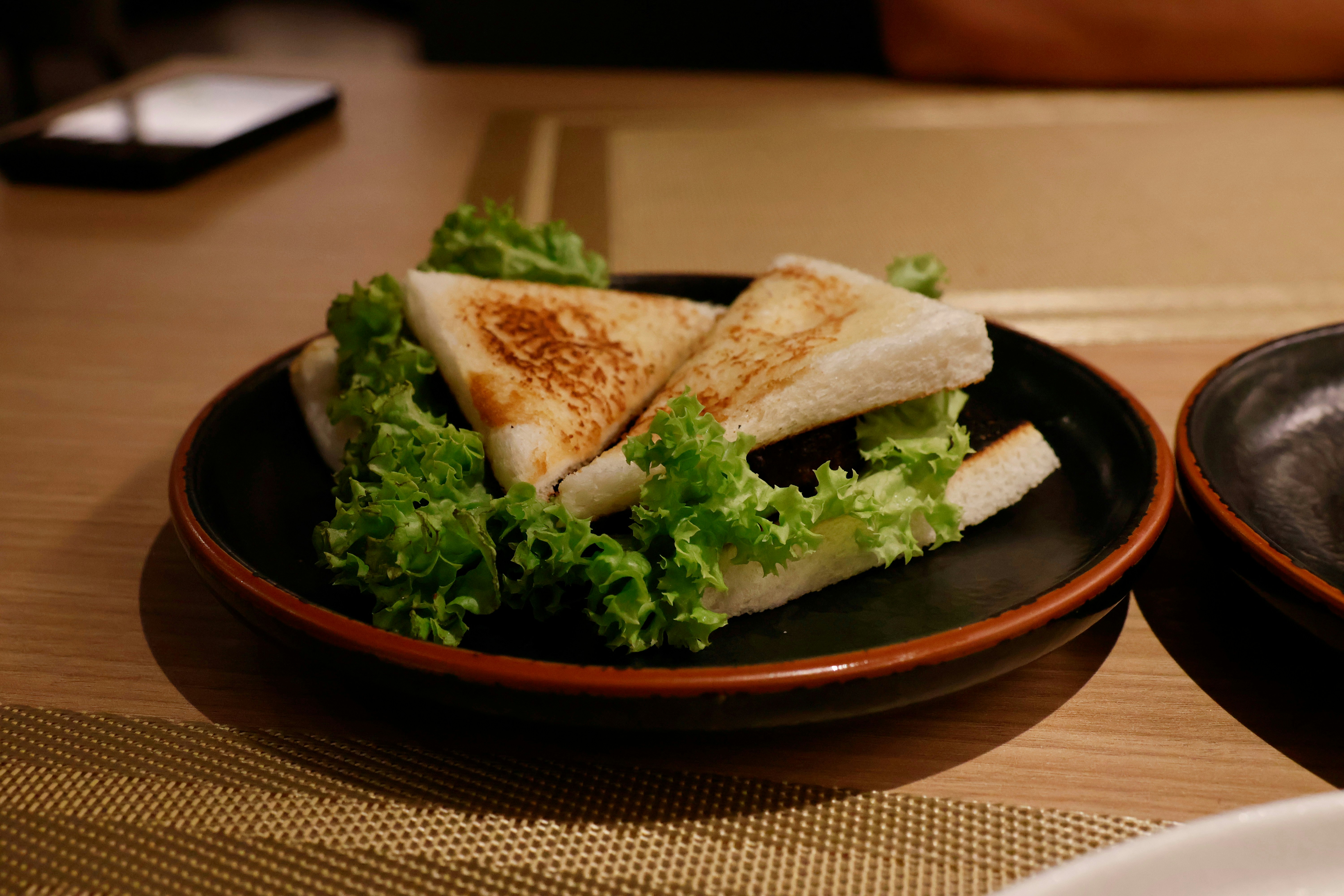 Grilled Club Sandwich on a Round Plate with Lettuce