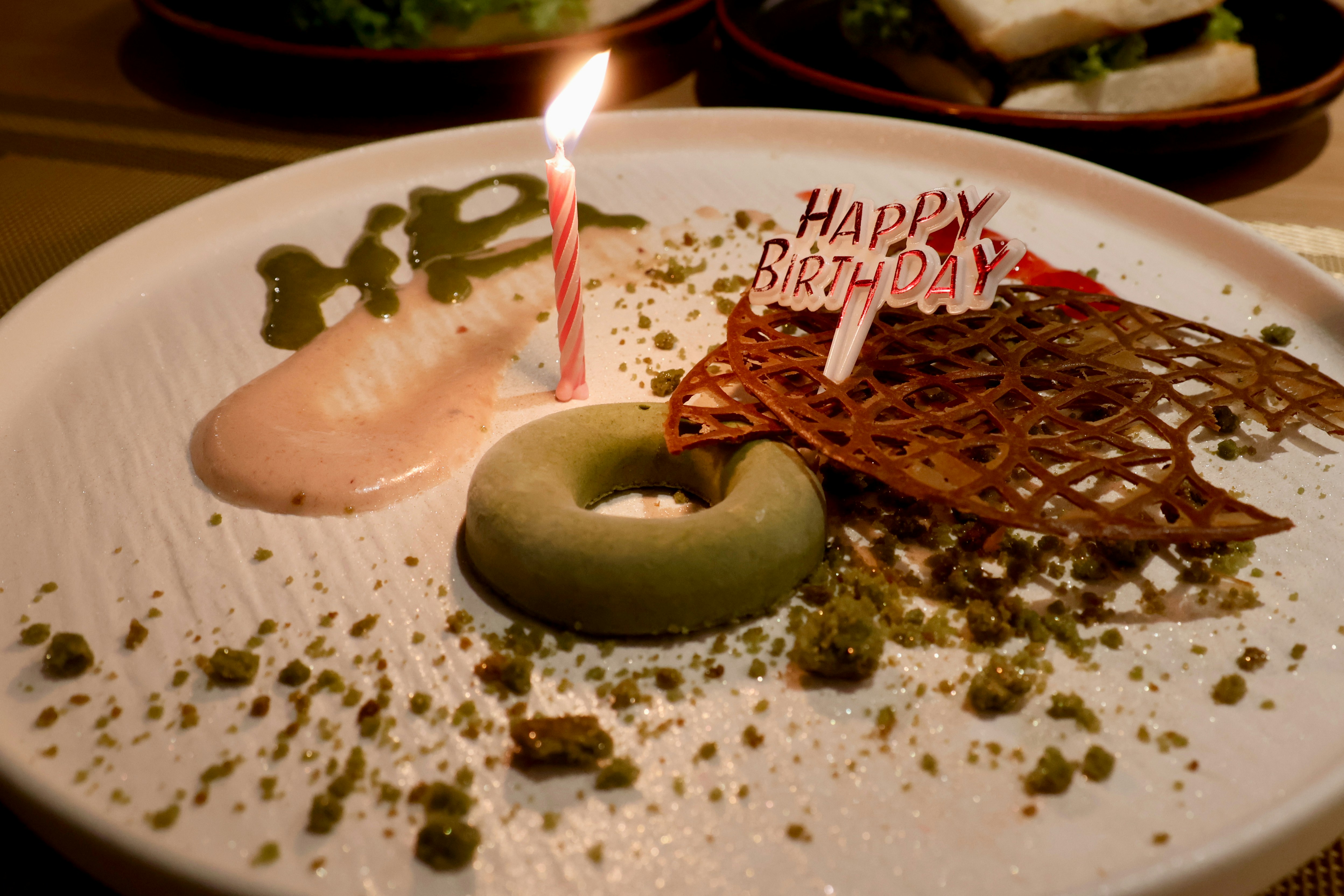 Candlelit Birthday Plate: Green donut, delicate lattice, and panna cotta