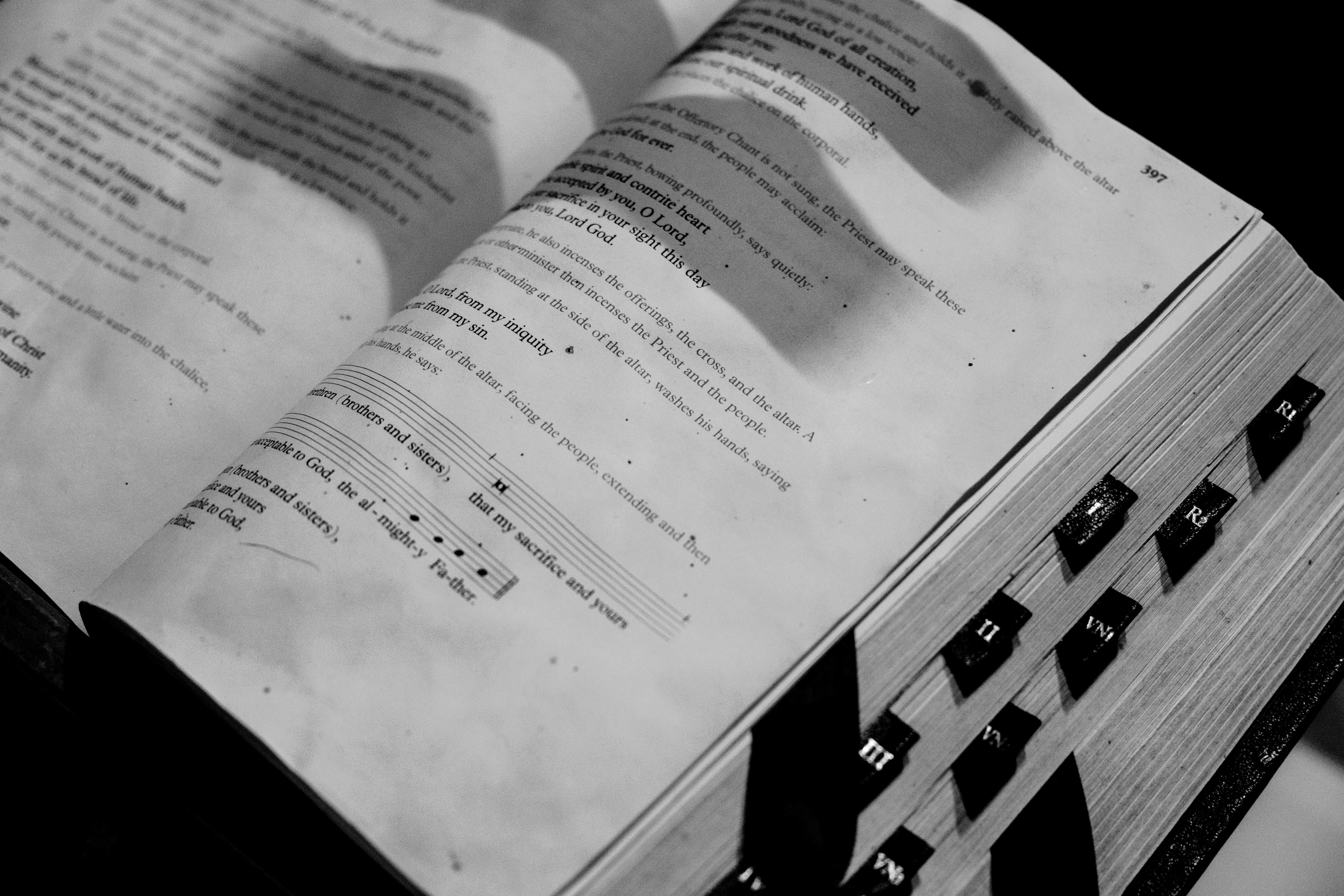 Close-up of a tilted open book with keyboard-like binding in grayscale