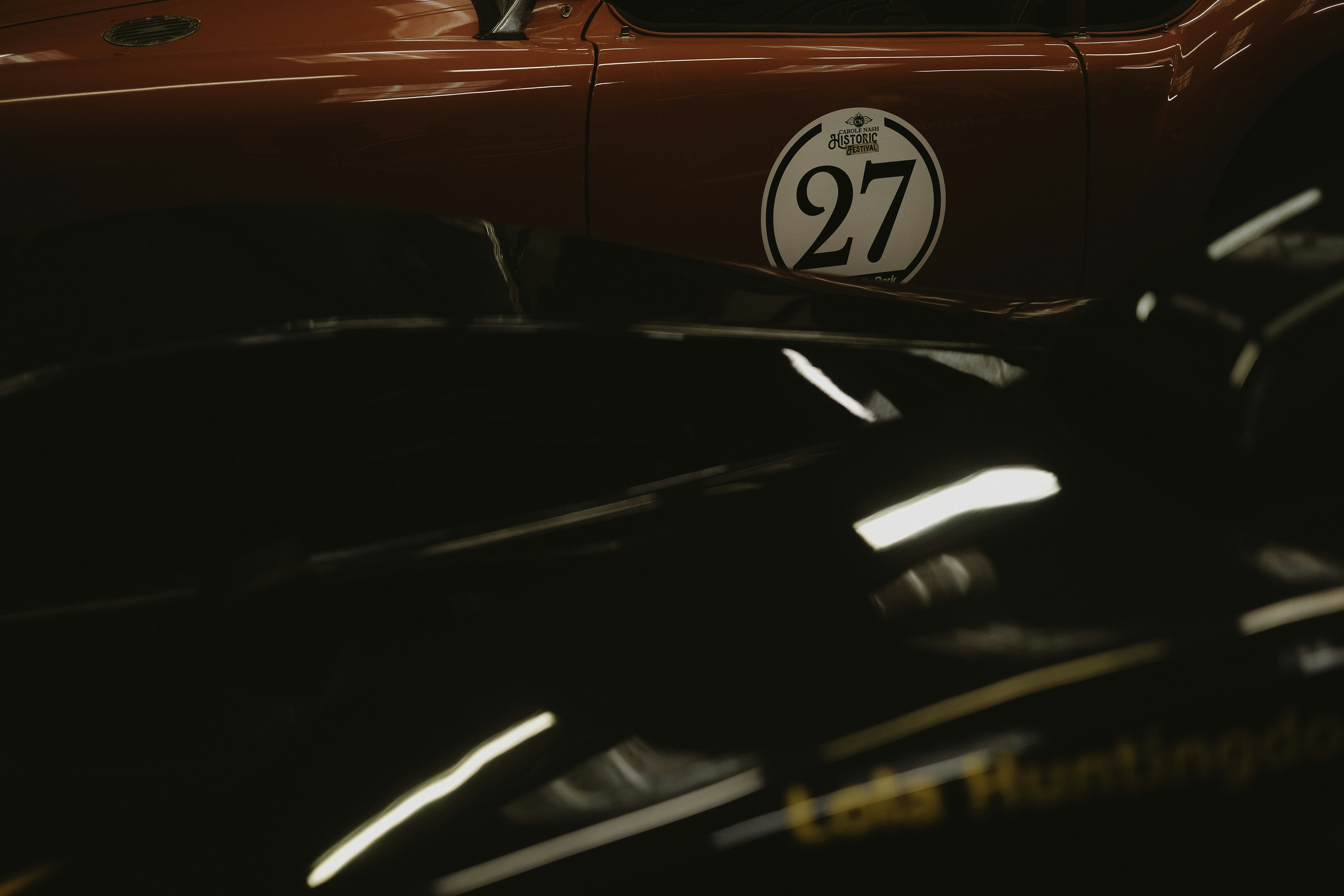 Red Racing Circles: A Vintage Car Race Number in Low Light