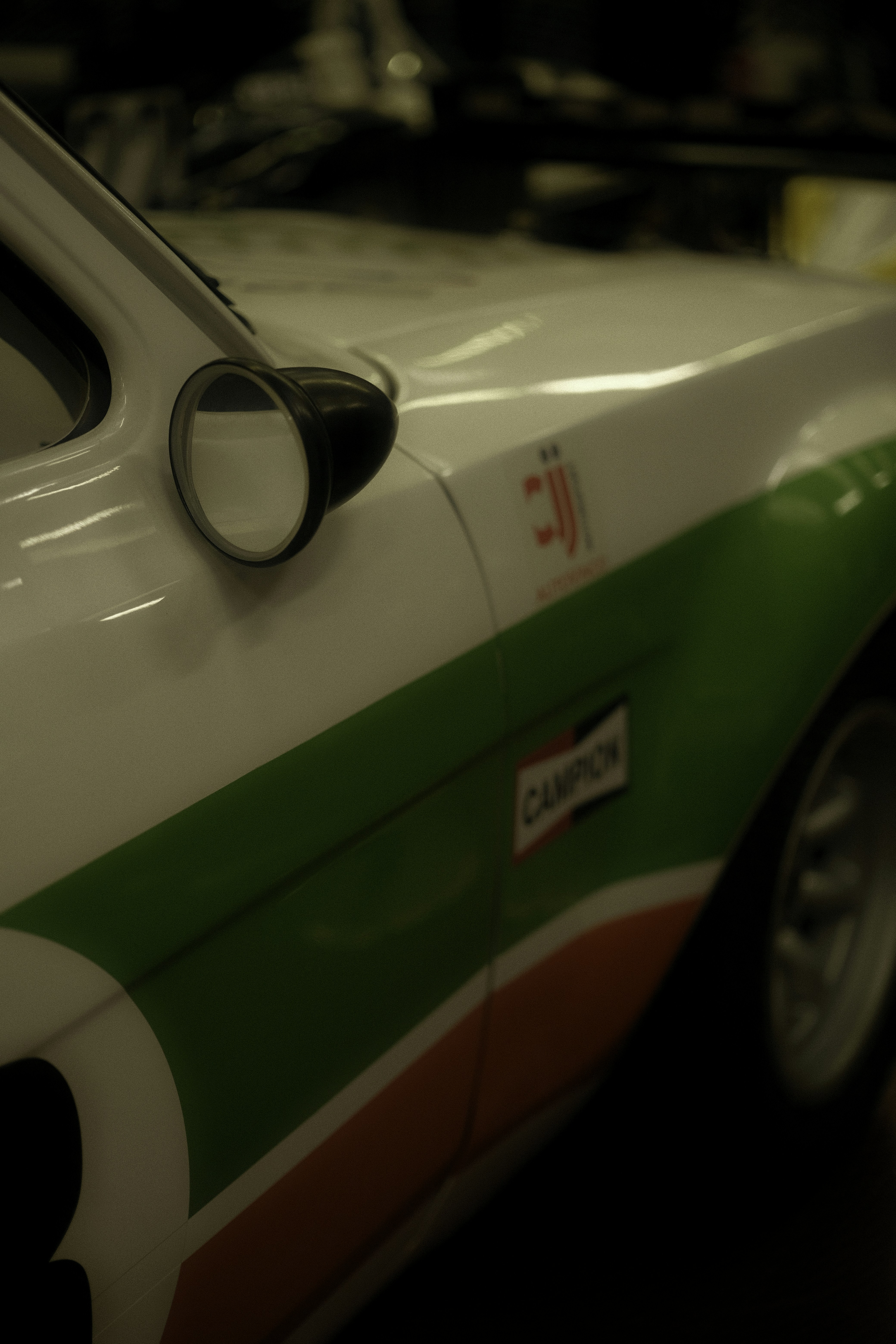 Green-and-white Racing Classic: A Curved View of a Vintage Car