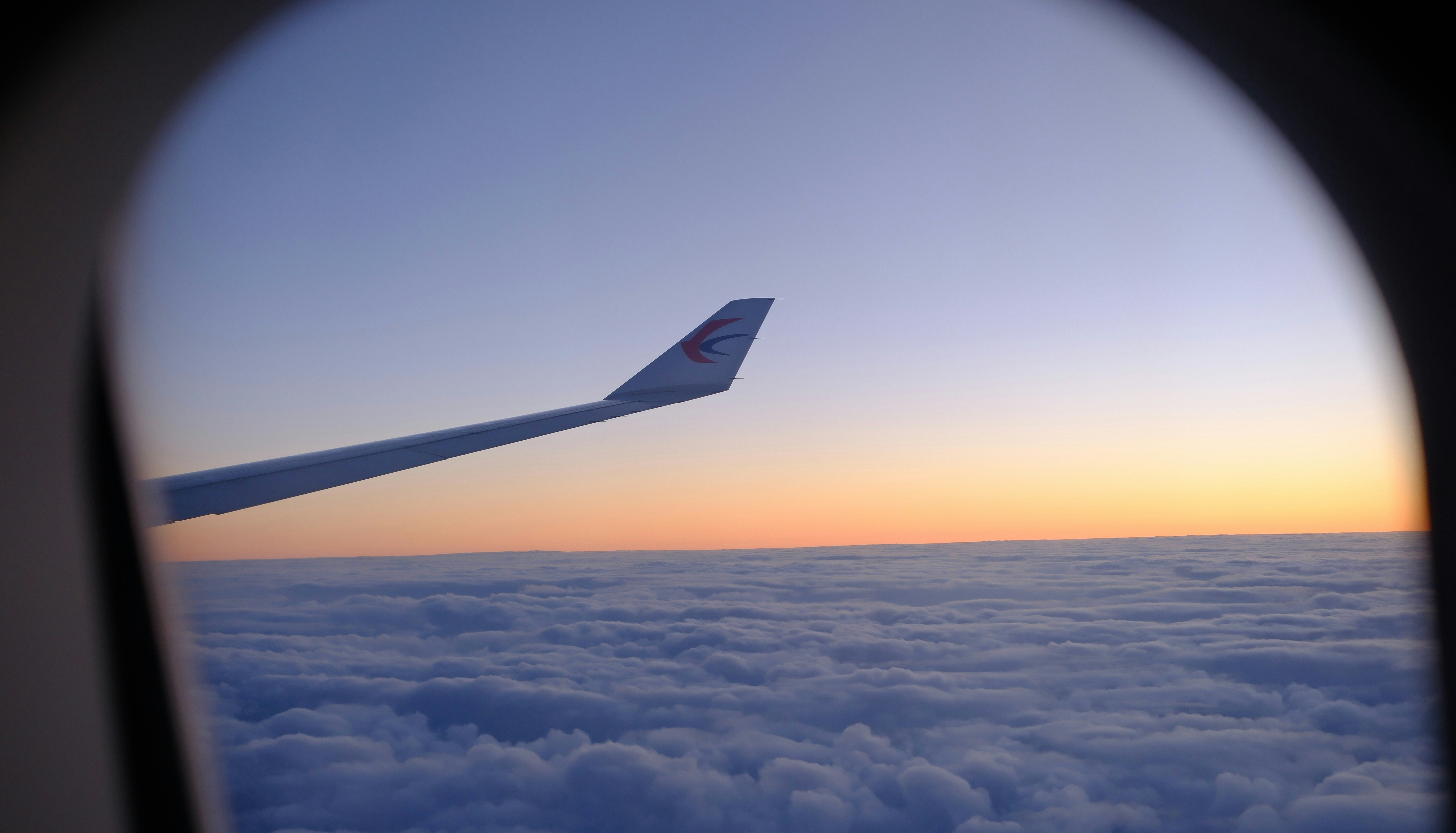 Wingtip Against the Sunset: Quiet Horizon from Window View