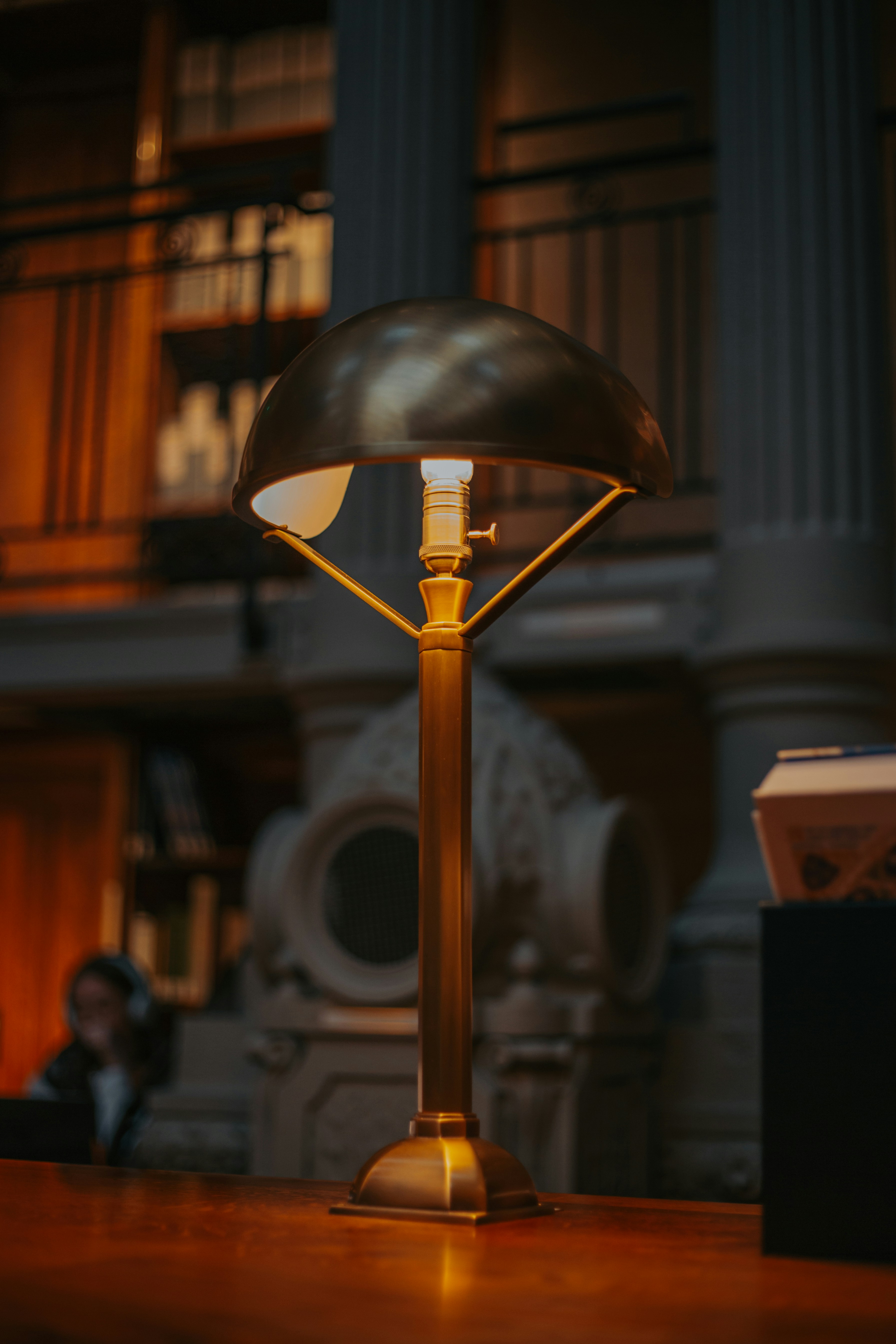 Warm Glow: A Brass Desk Lamp in a Library Setting
