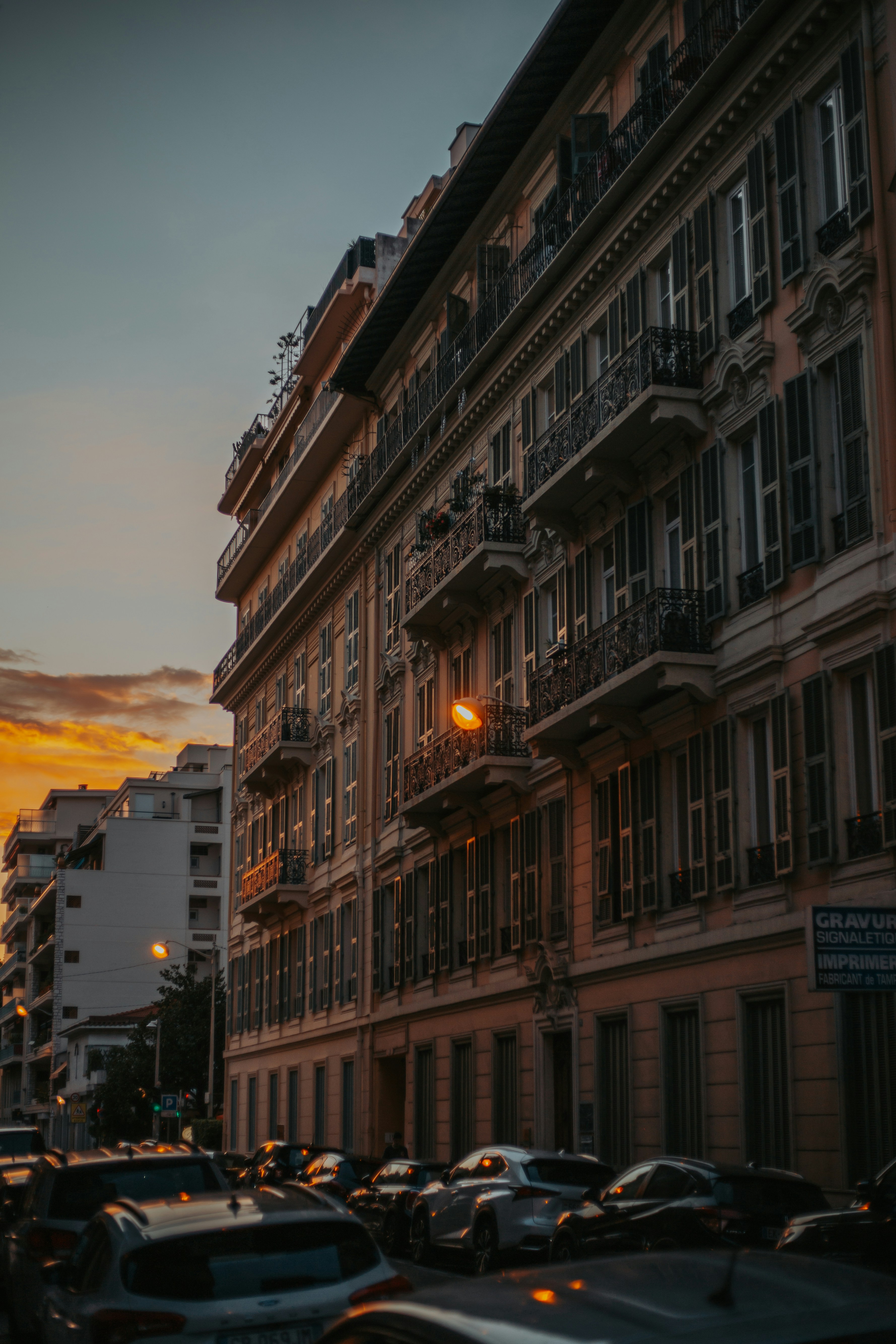 Sunset Over a Parisian Street: Shadows, Steel and Streetlamps