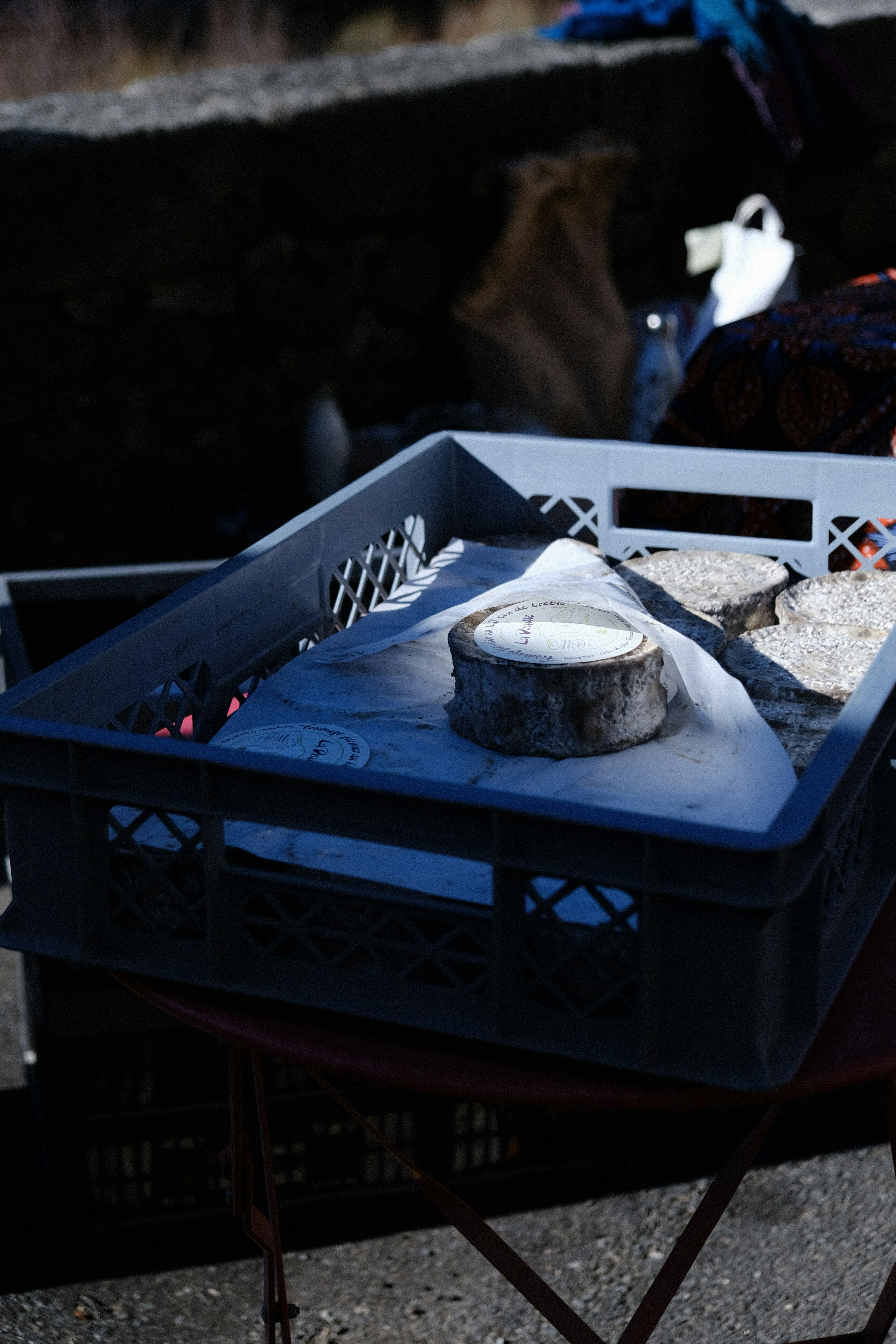 Blue Crate Still Life: A Rustic Work Surface Under Evening Light
