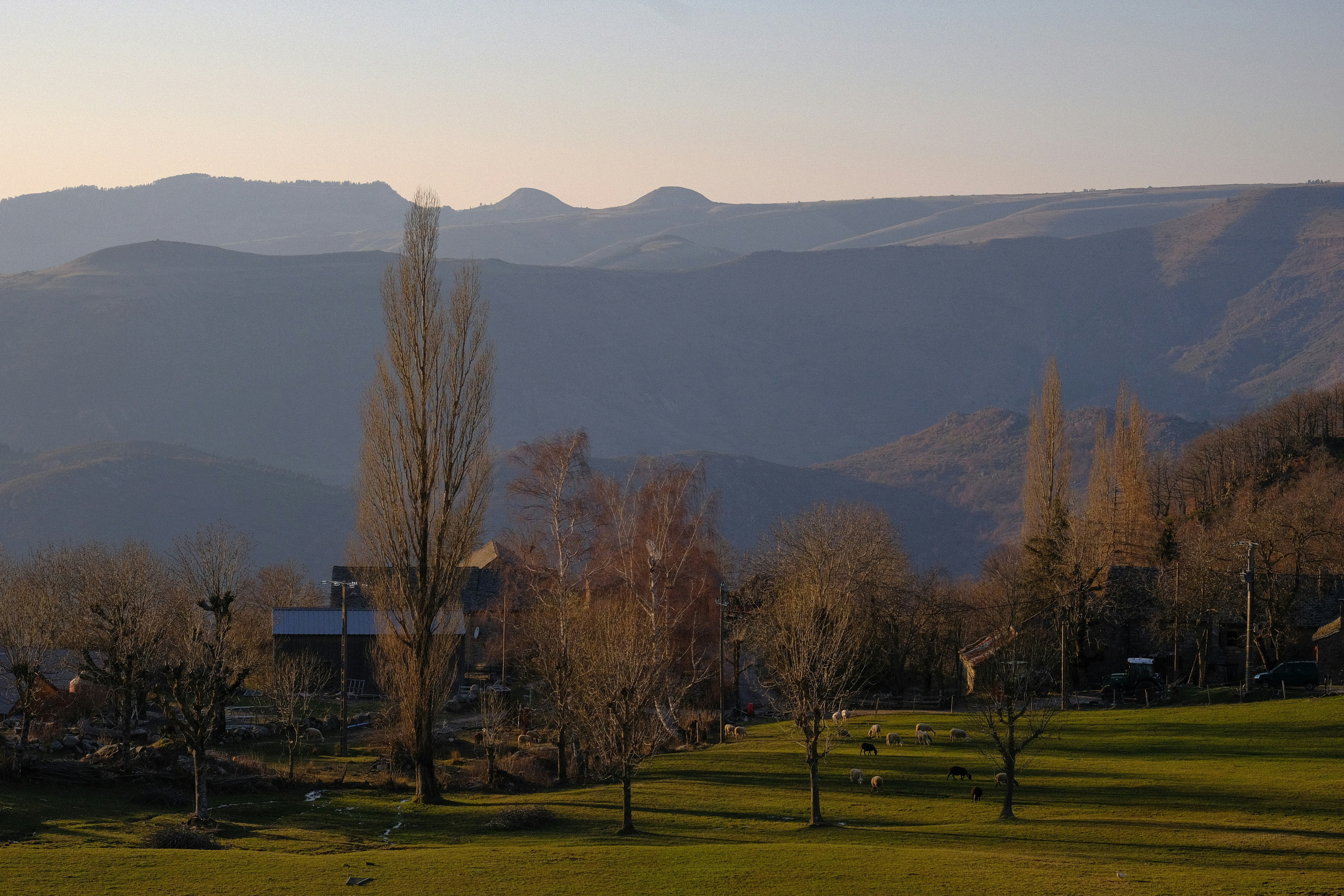Quiet Park Beneath Distant Blue Ridges at Dusk