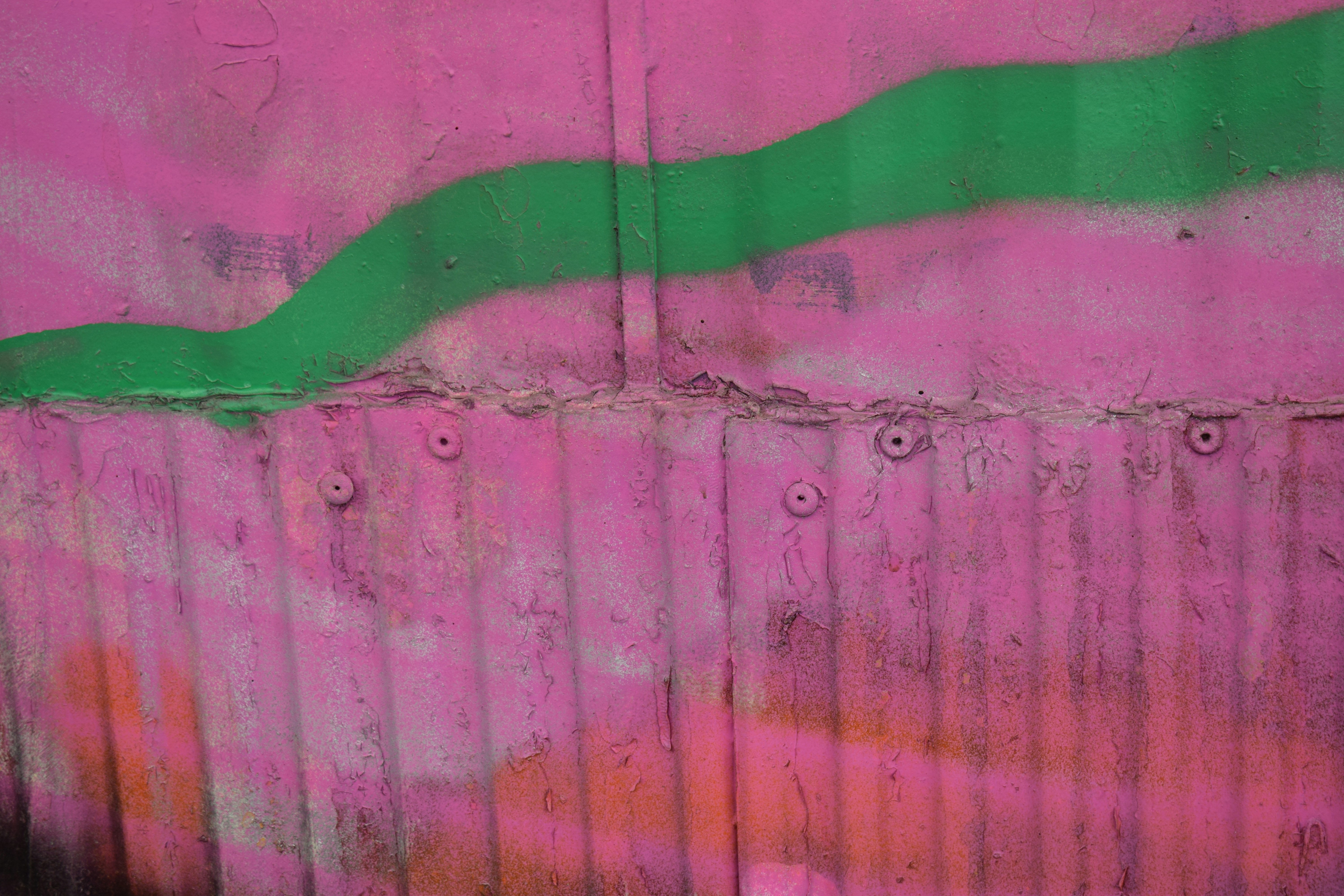 Neon Graffiti Waves on Weathered Concrete