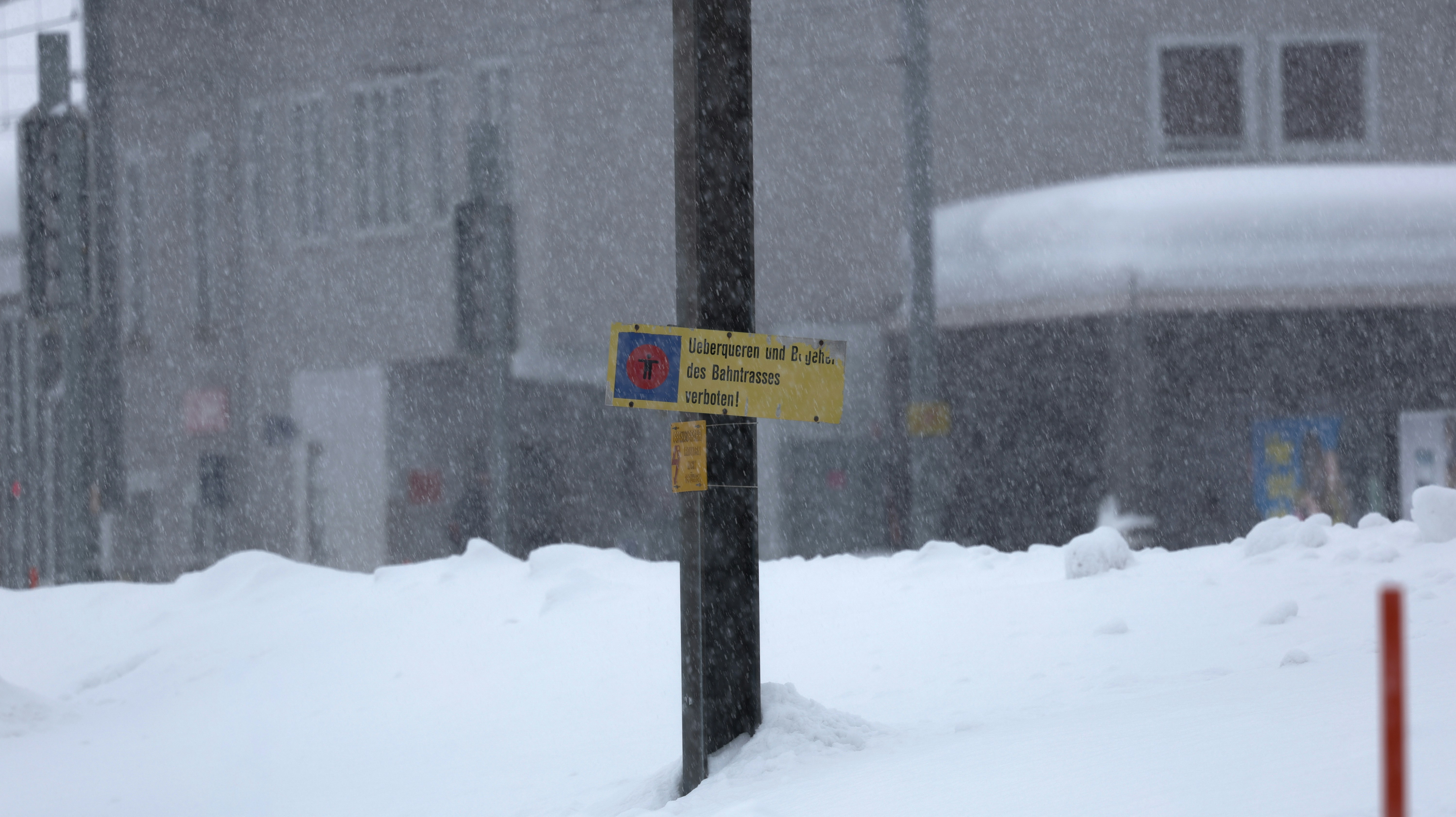 Snowy Street Sign Propped by a Snowbank