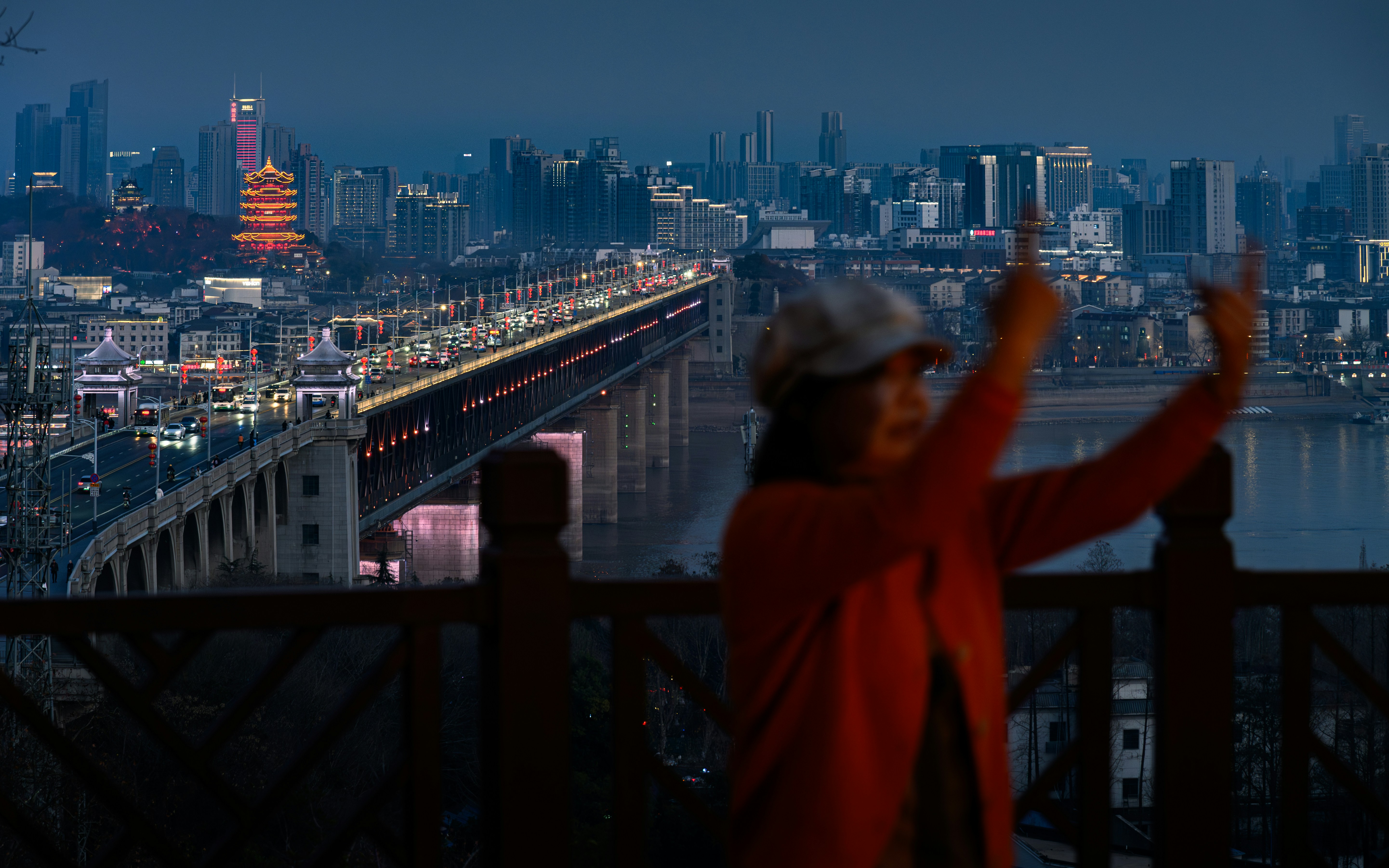 Cityscape Echoes: Night Bridge and the Silhouetted Attendant