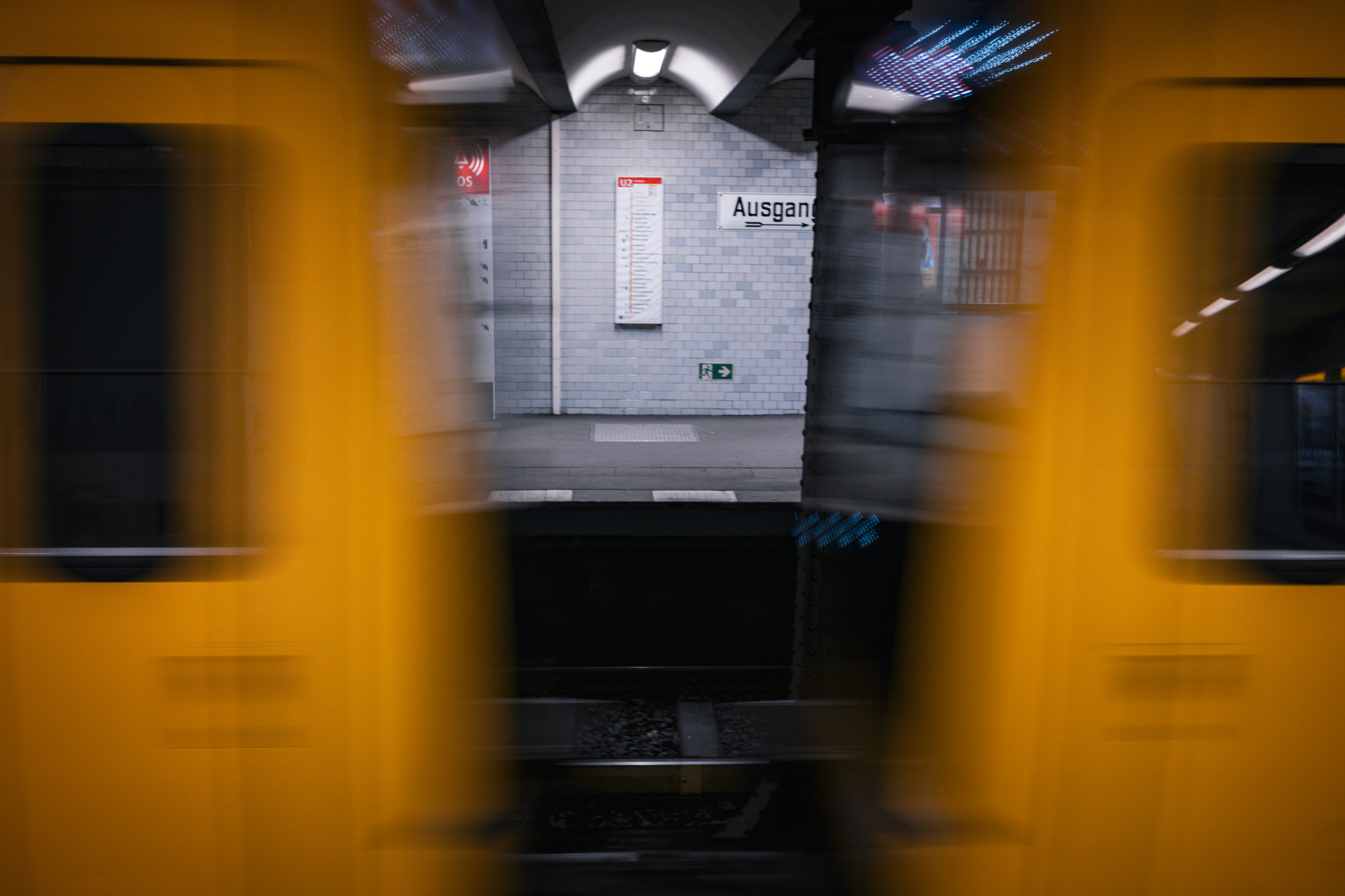 Midweek Subway Blur: A Yellow Carriage Framing the Quiet Platform