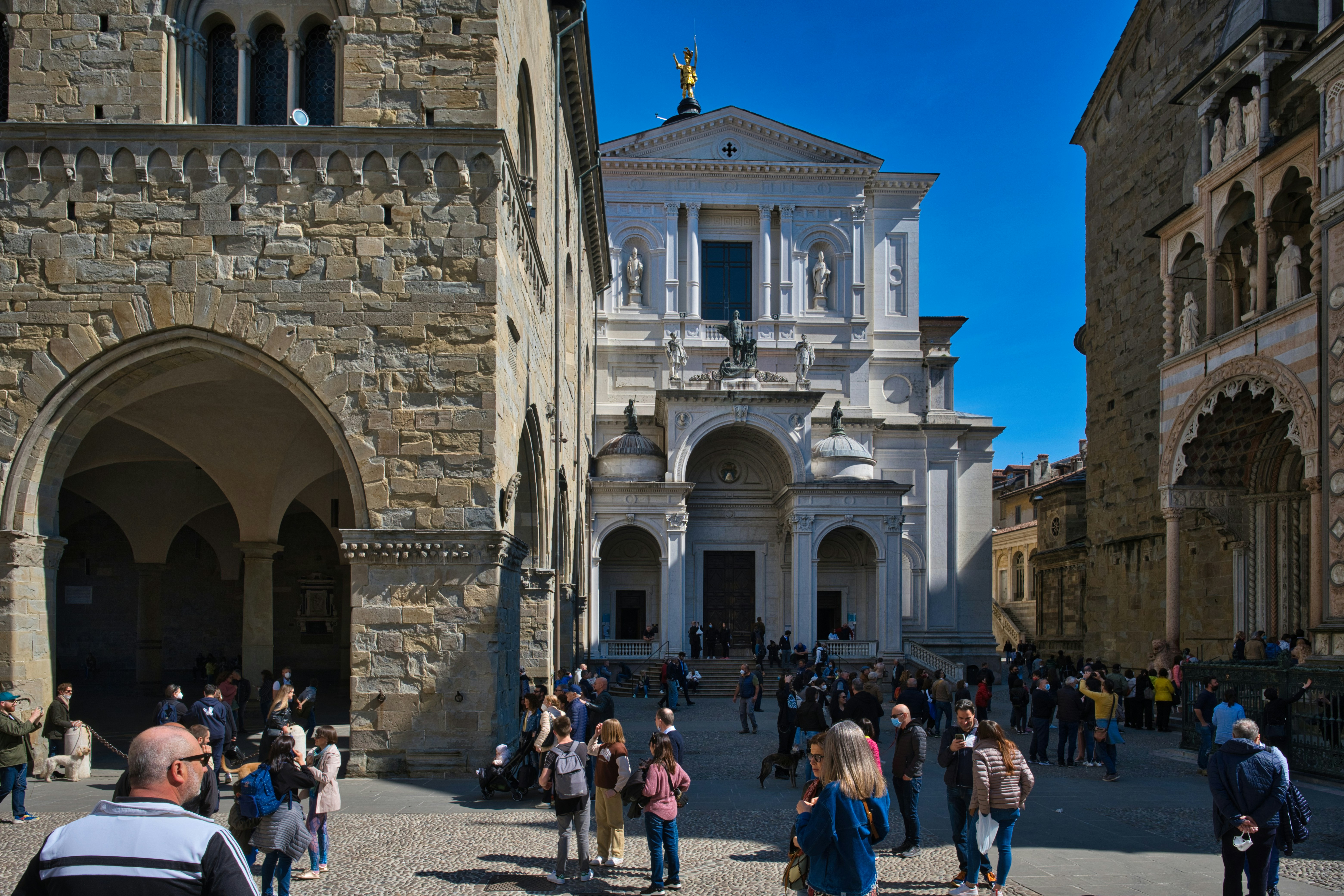 Central Facade, Crowds and Arched Courtyard of a Historic Italian Square