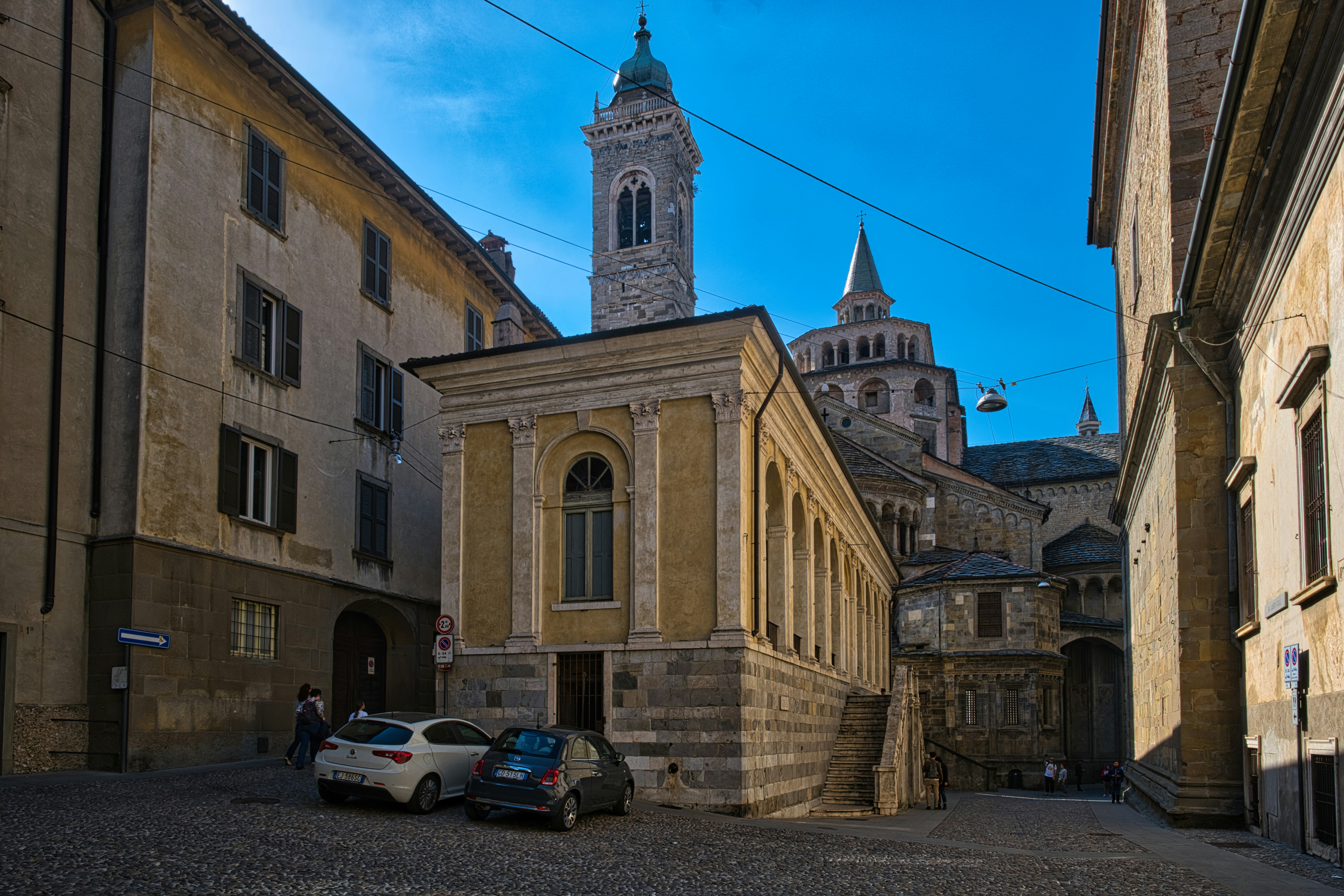 Cobbled Piazza with Historic Facades and Towering Bell Tower
