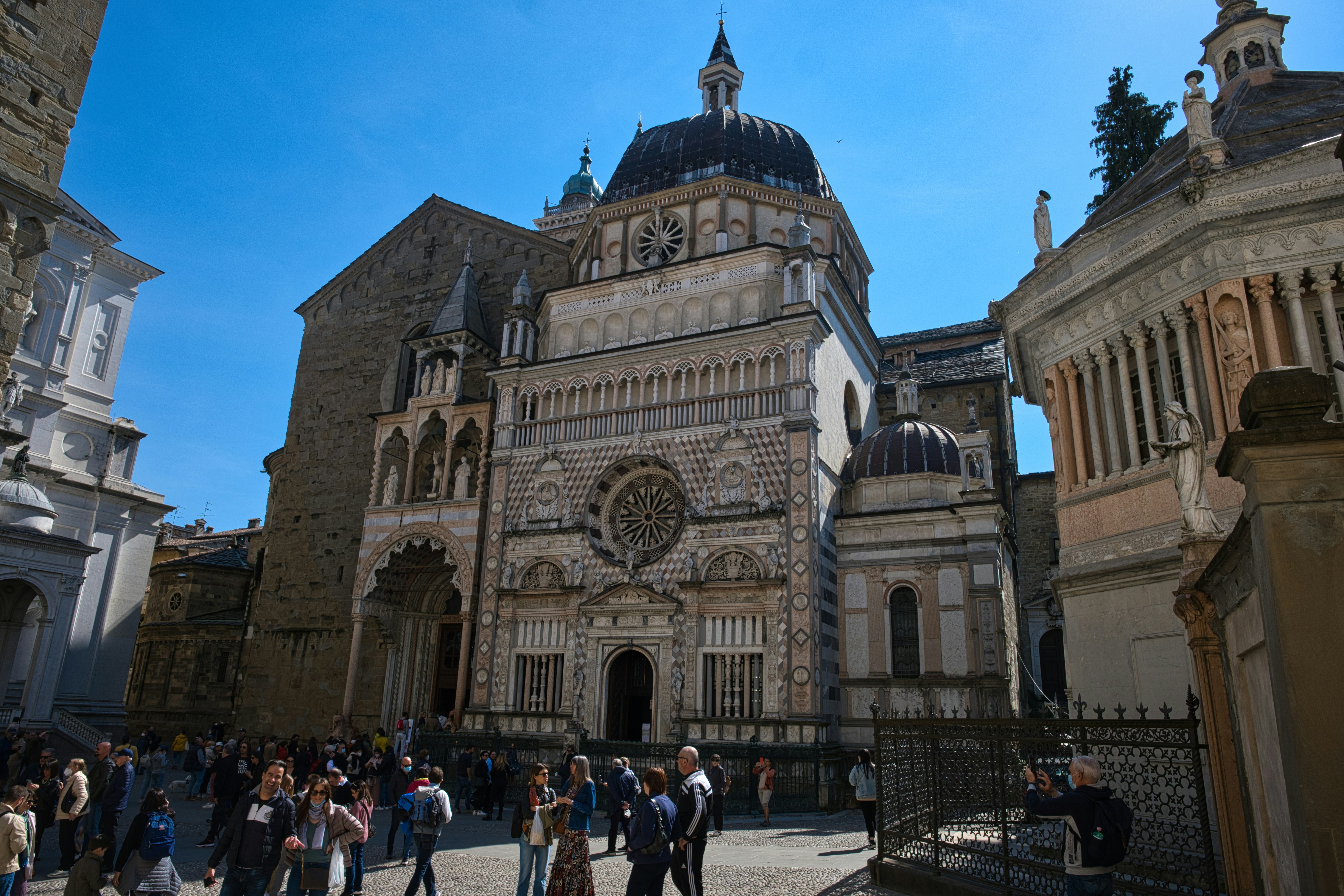 Facade of Zuccaro Cathedral: People Gather Before a Historic Holy Portal