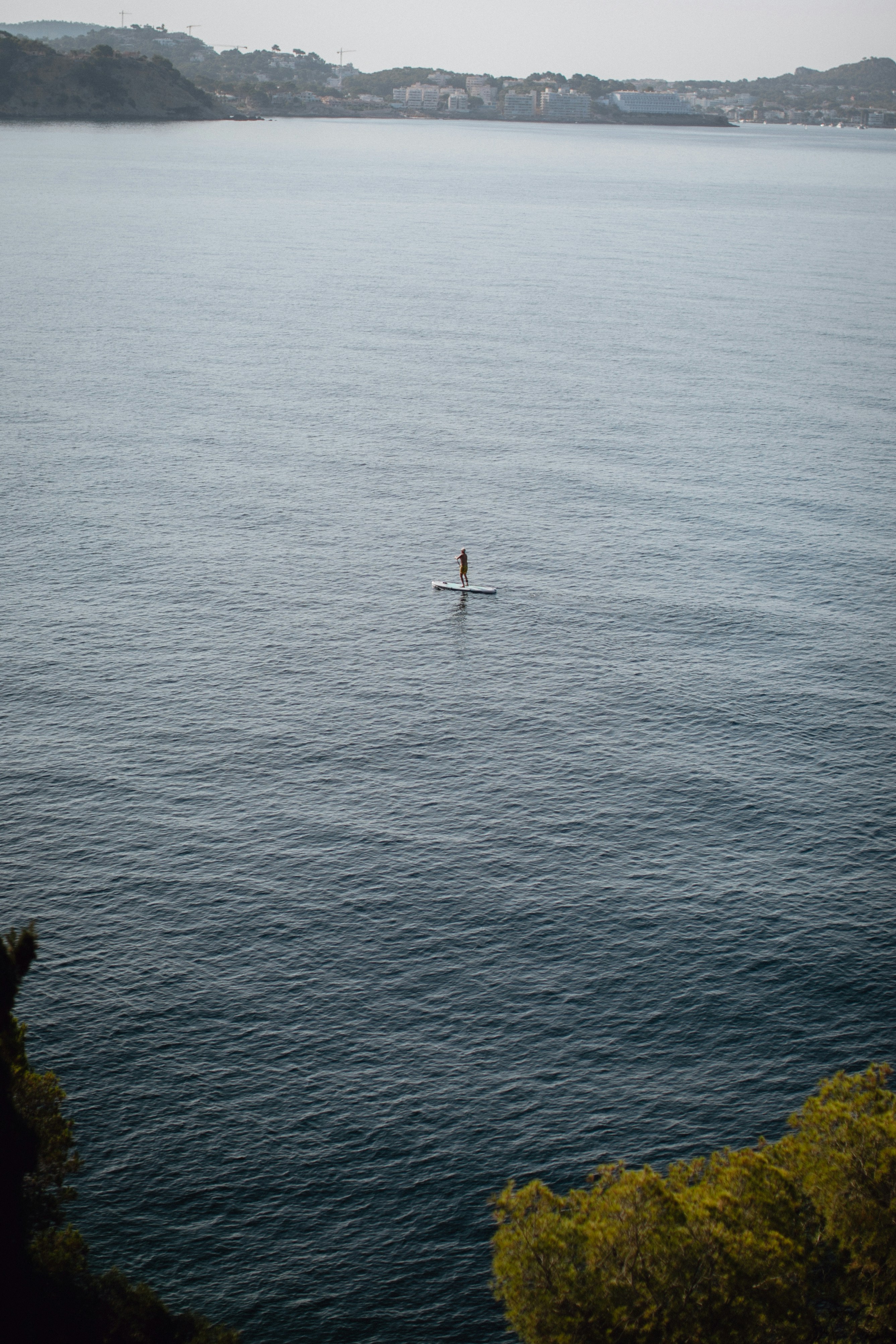 Lone Paddleboarder Amid Expansive Sea