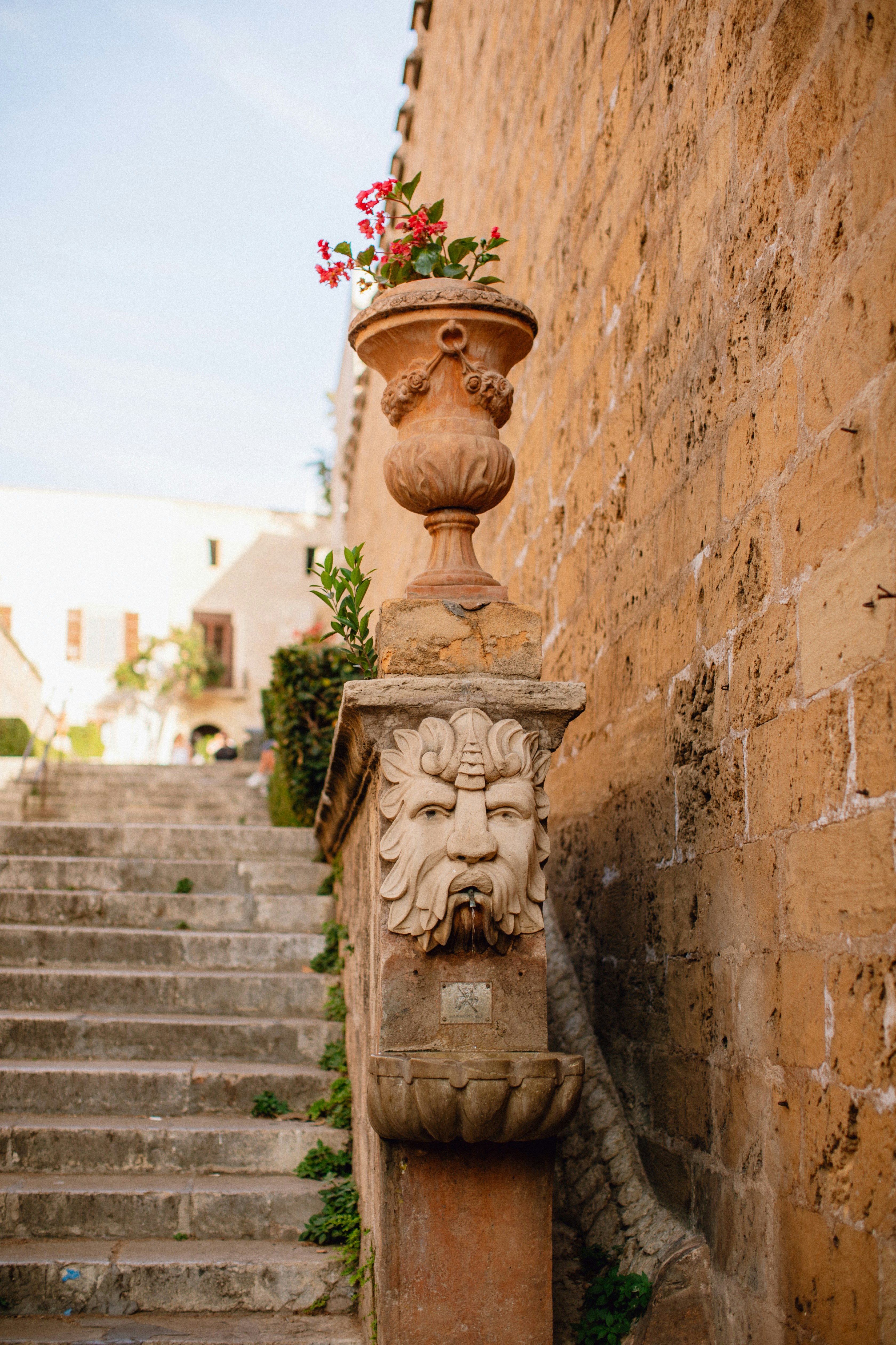 Stone Spout with Floral Urn: A Quiet Staircase Gallery