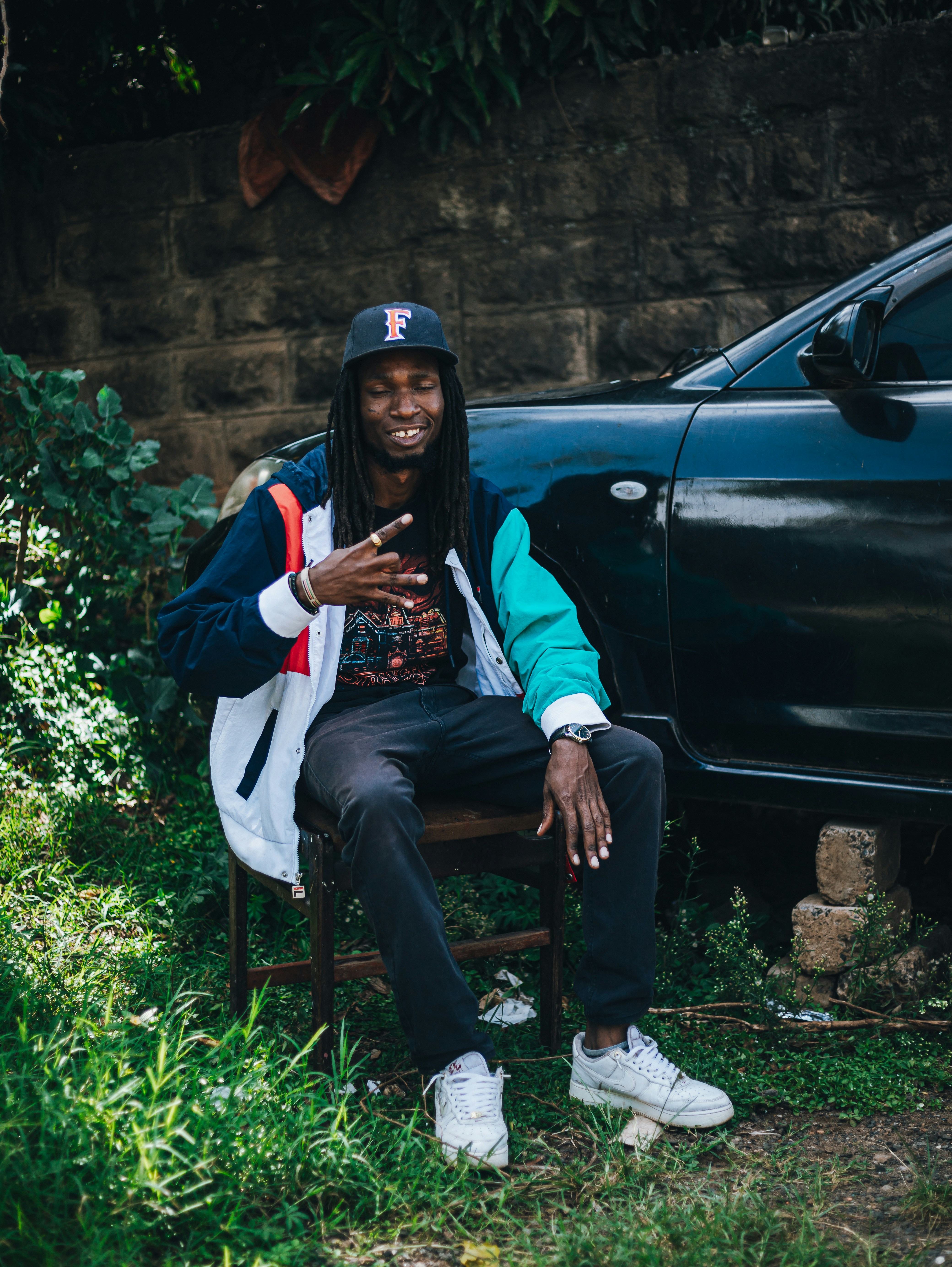 Chill Vibe by the Car: A Friendly Moment on a Sunny Yard