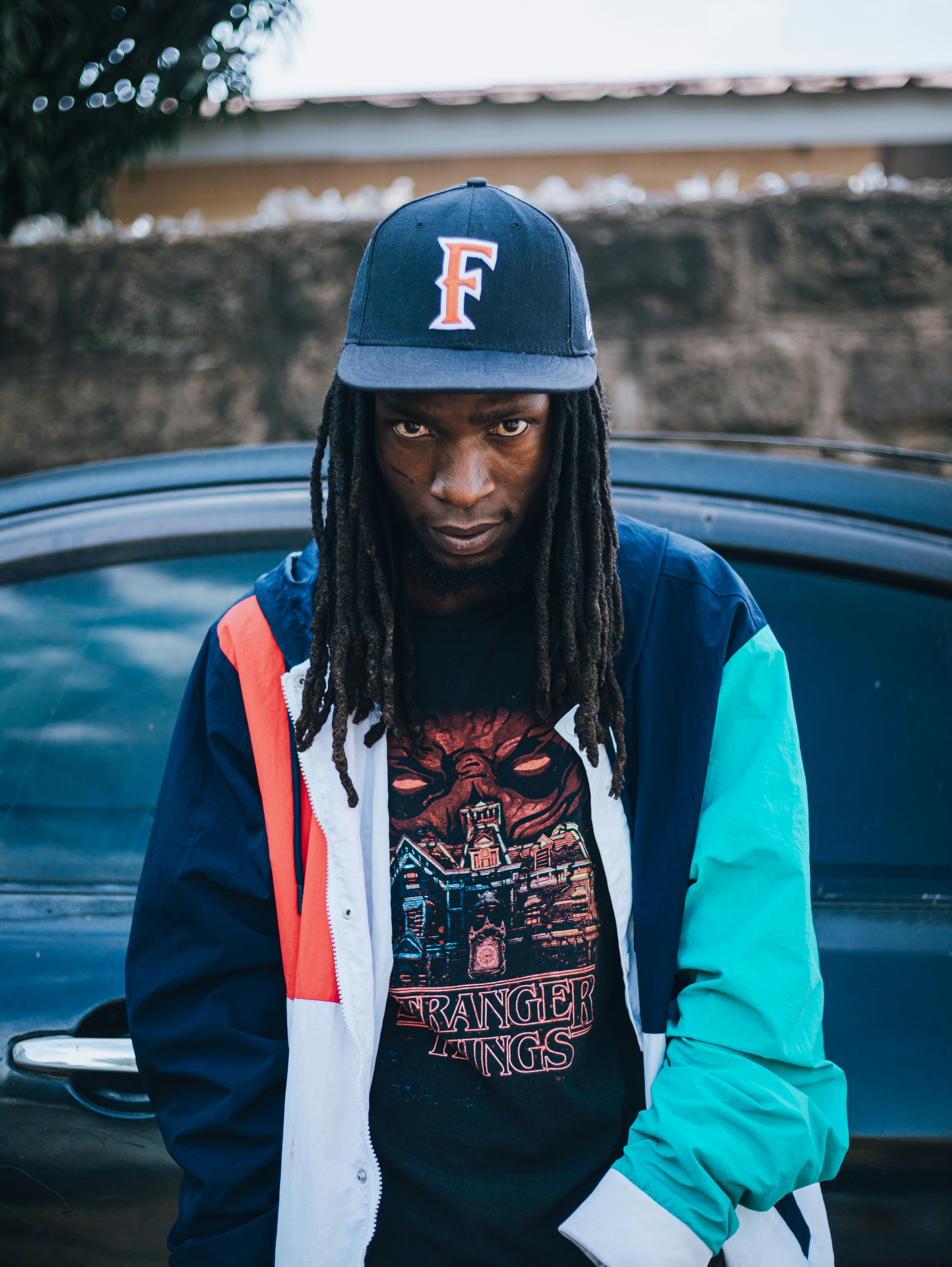 Centered Confidence: A Portrait with Colorful Streetwear under a Stormy Sky