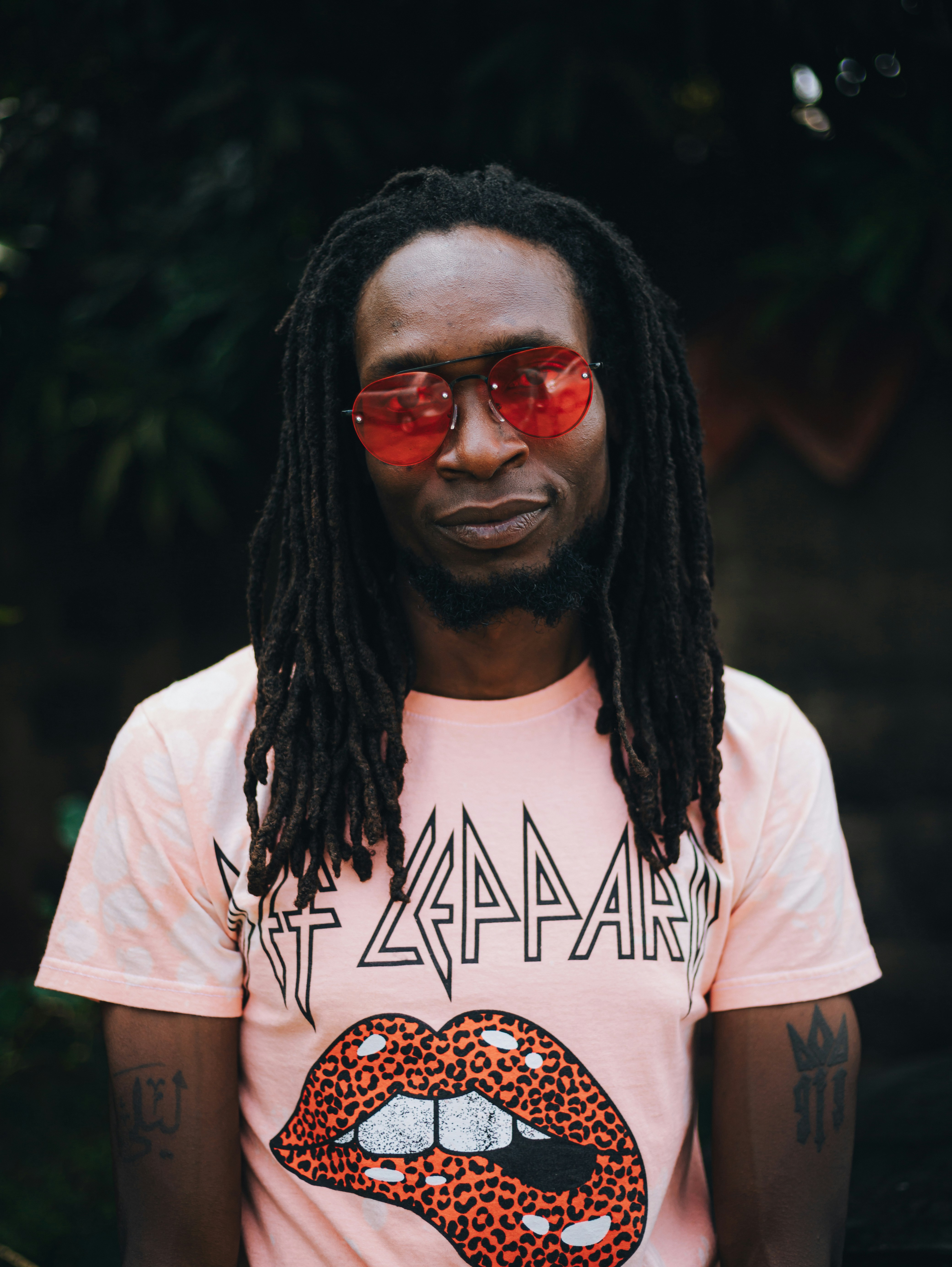 Neon-tinged Confidence: The Man in Pastel with Red Glasses