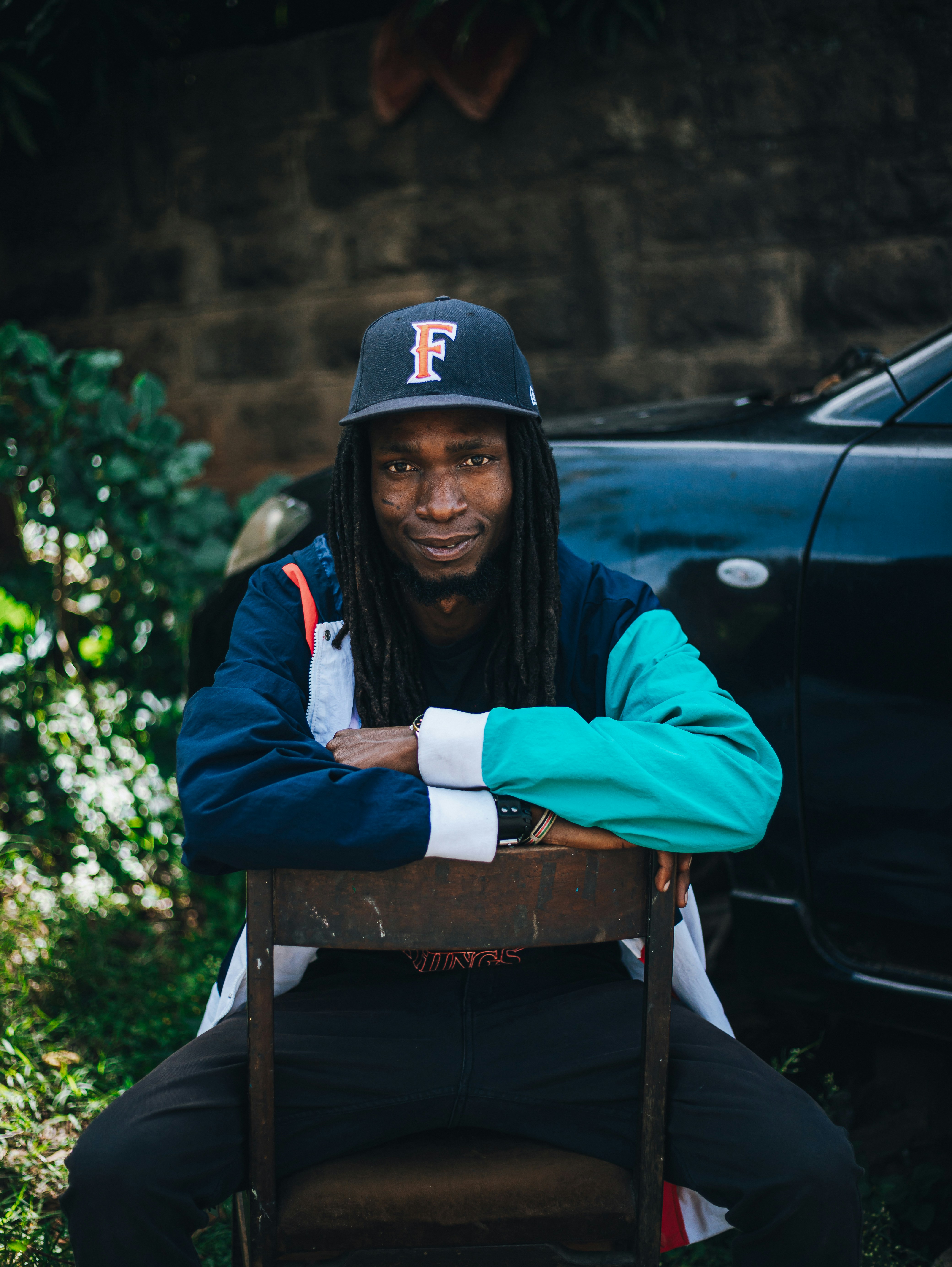 Chill Confidence: Portrait on a Quiet Street with a Car Backdrop