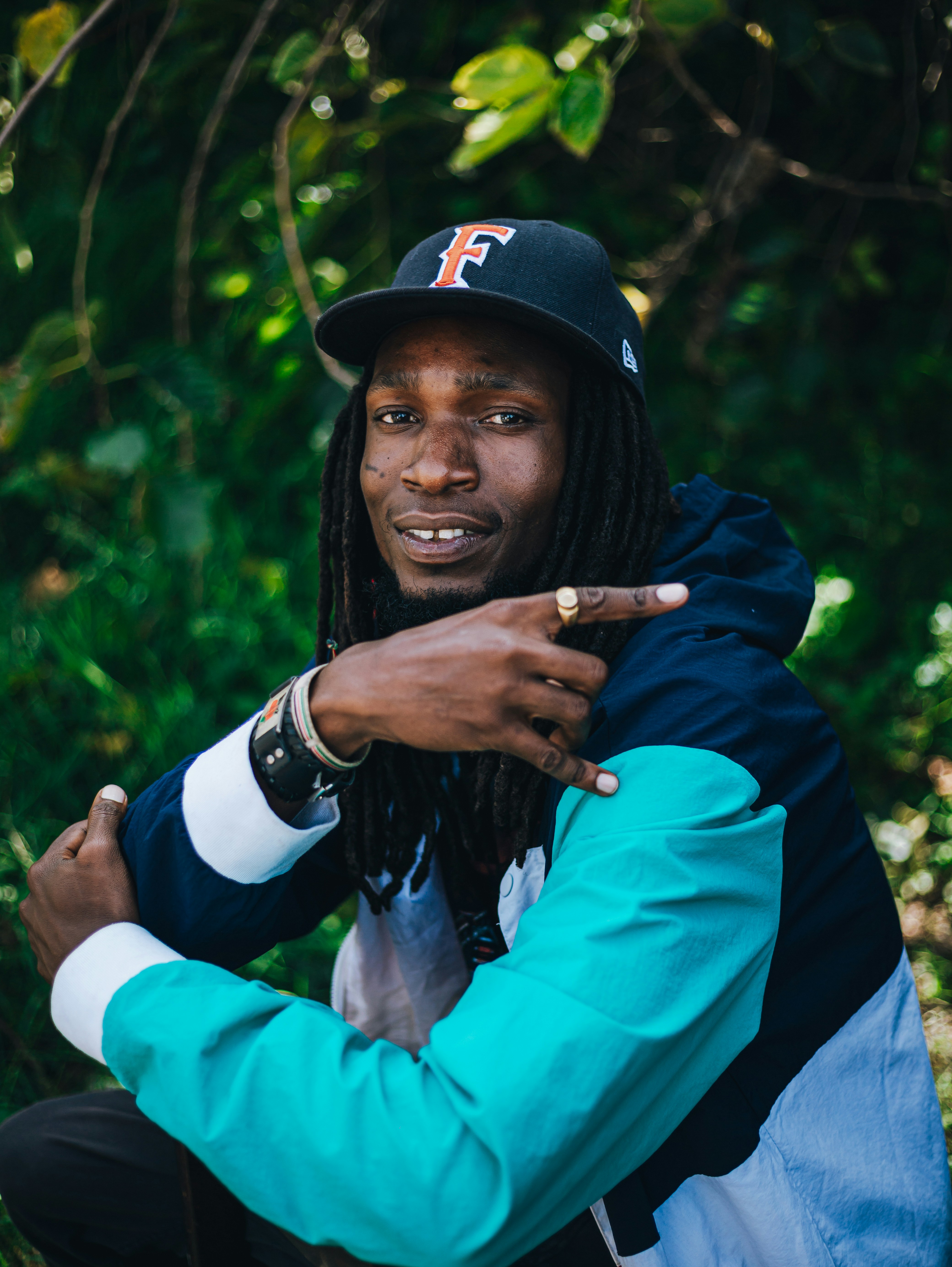 Portrait on the Edge: A portrait in streetwear against green foliage