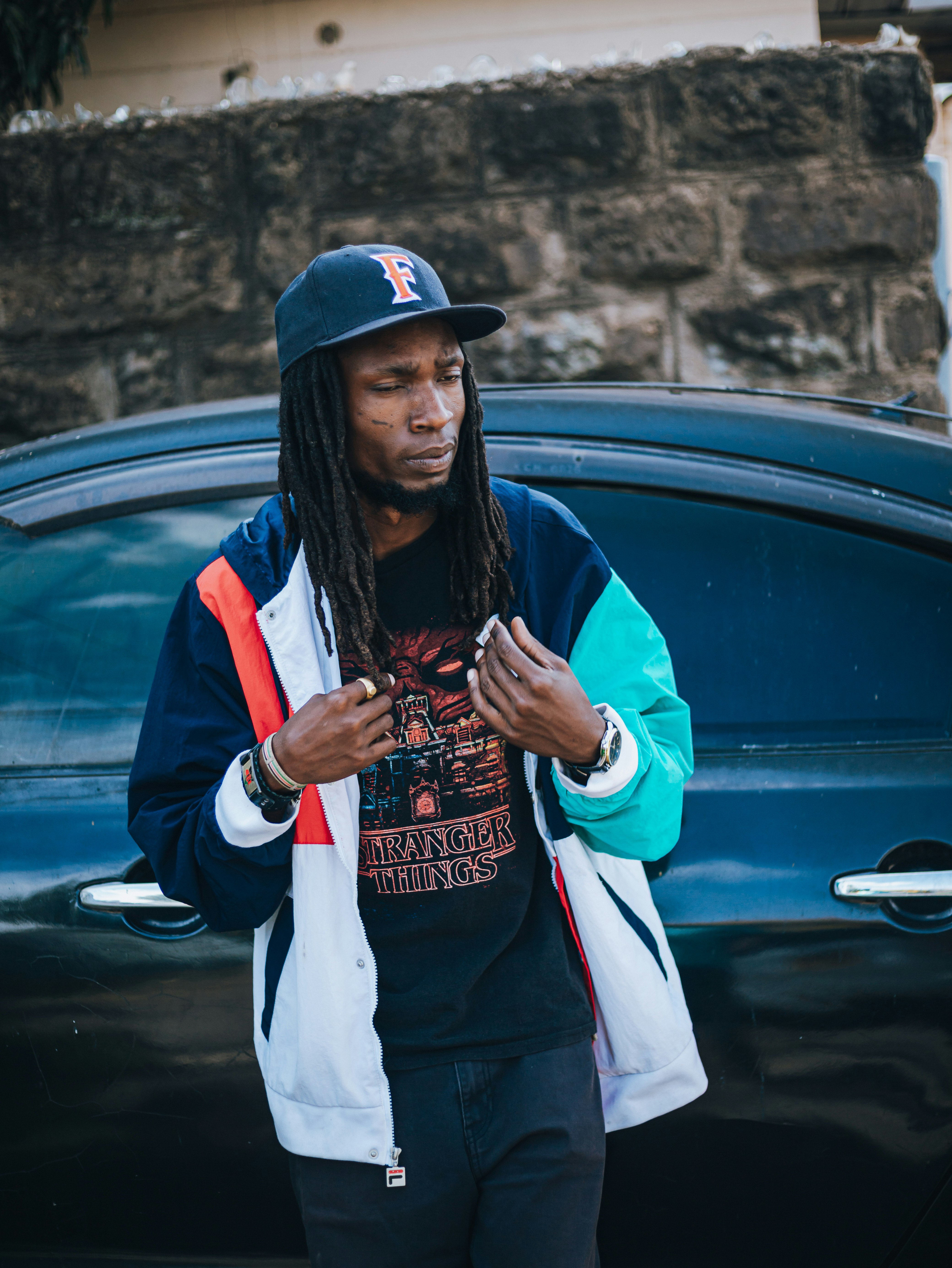 Portrait of Confidence: Streetwear and Shadowed Face by the Car
