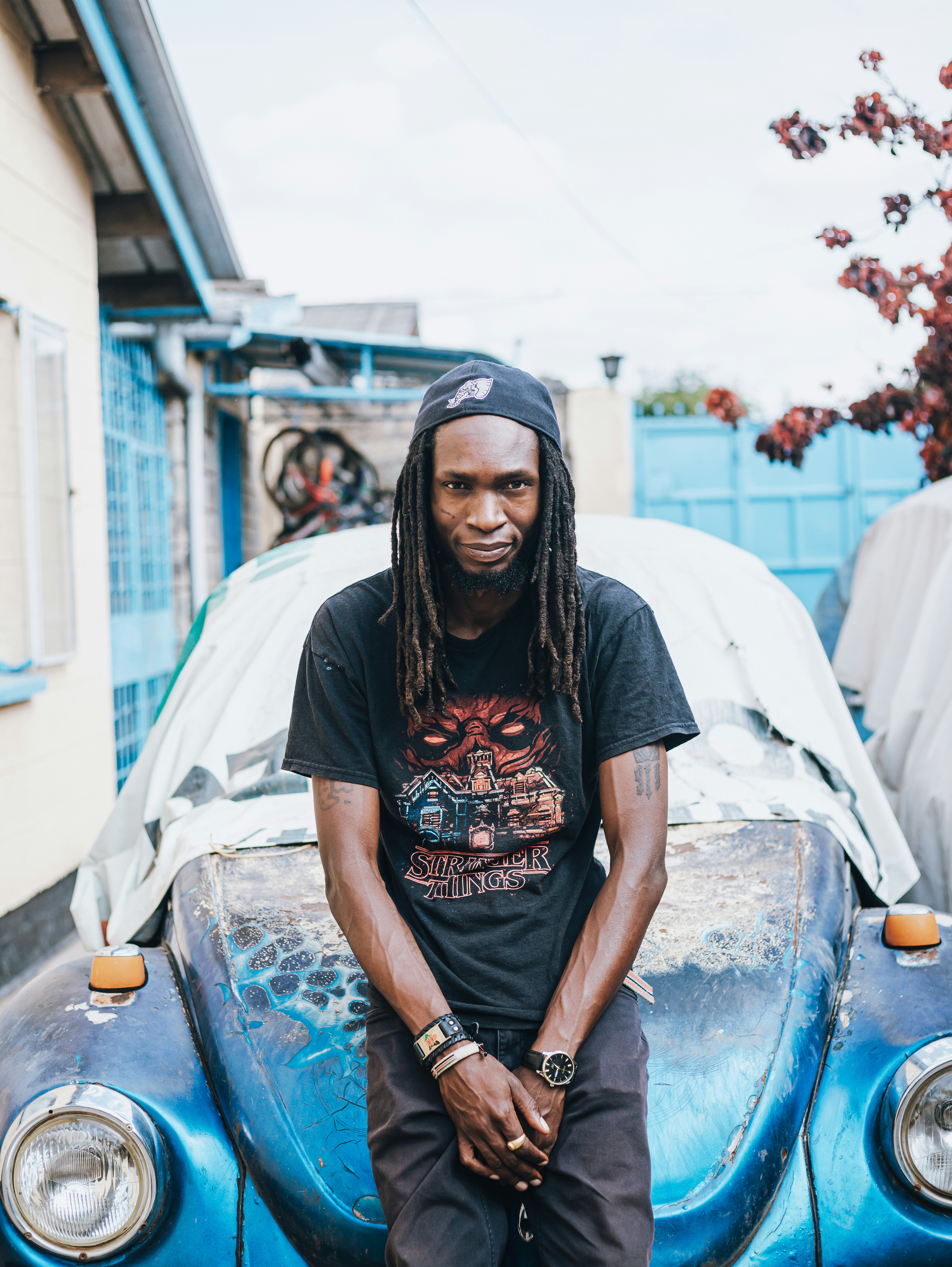 Midfield Resolve: Man in Black at the Car Yard Gate