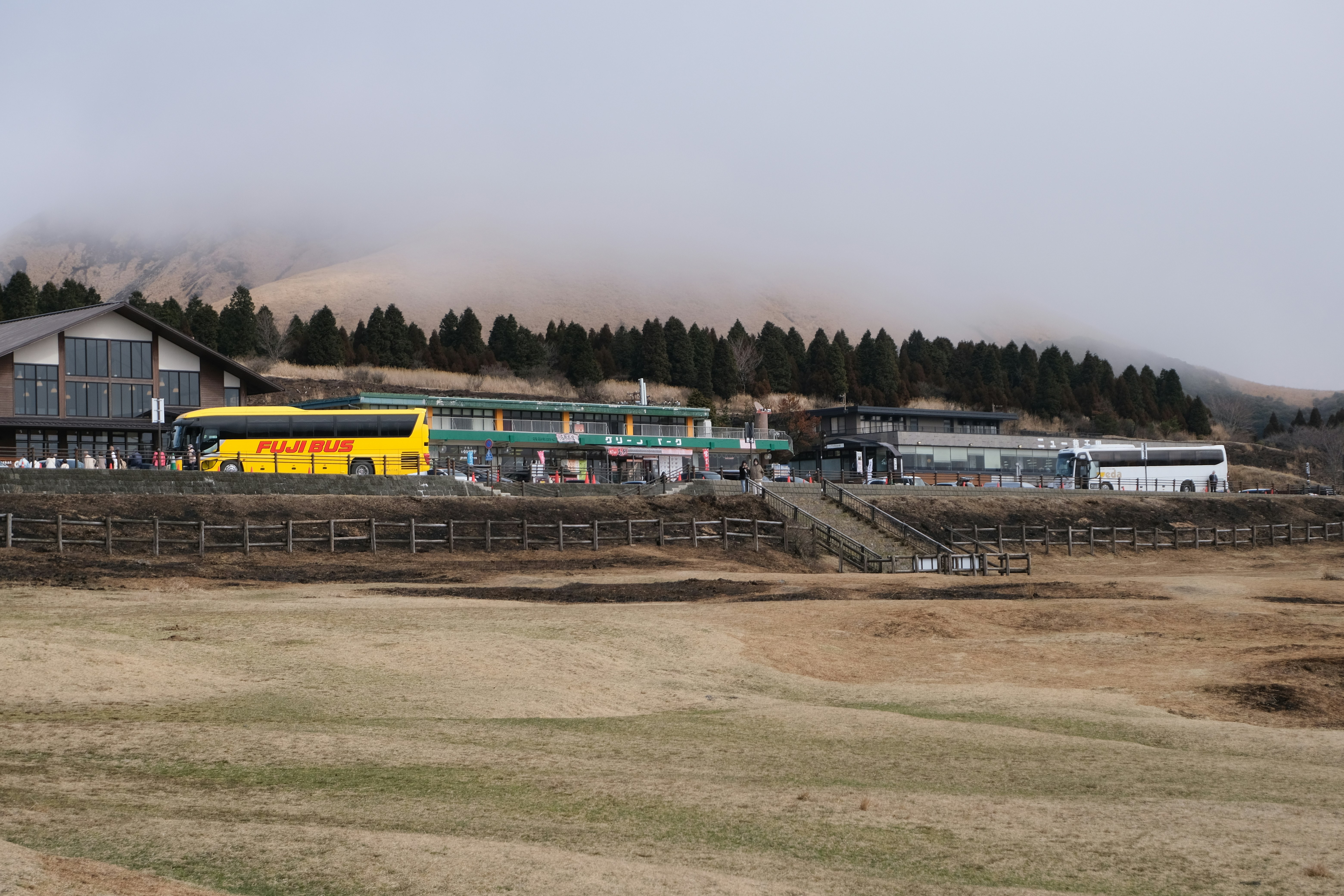 Yellow Bus at the Edge of a Foggy Bus Depot