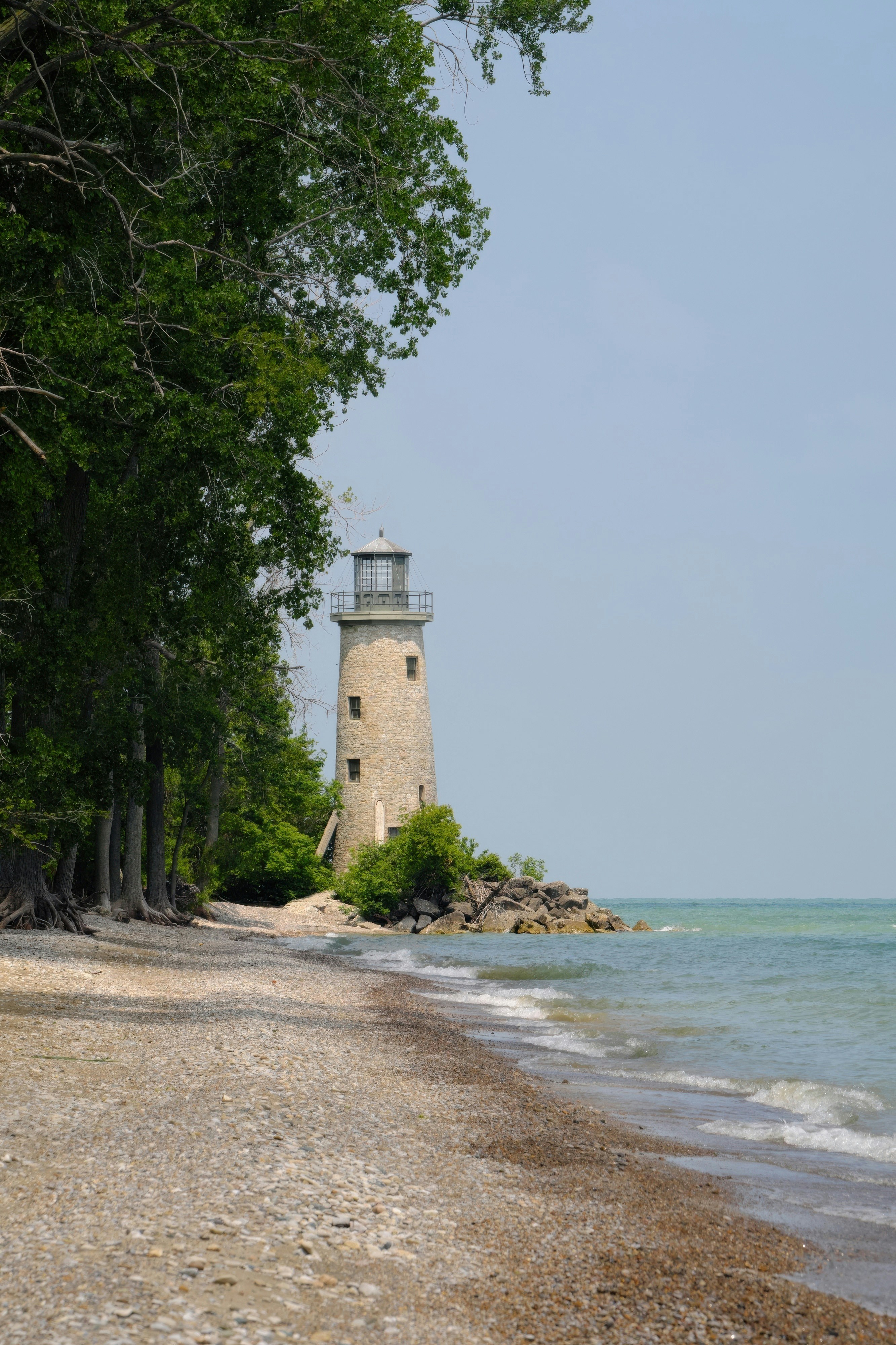 Lighthouse on the Quiet Shore: A Sunlit Beach Portrait