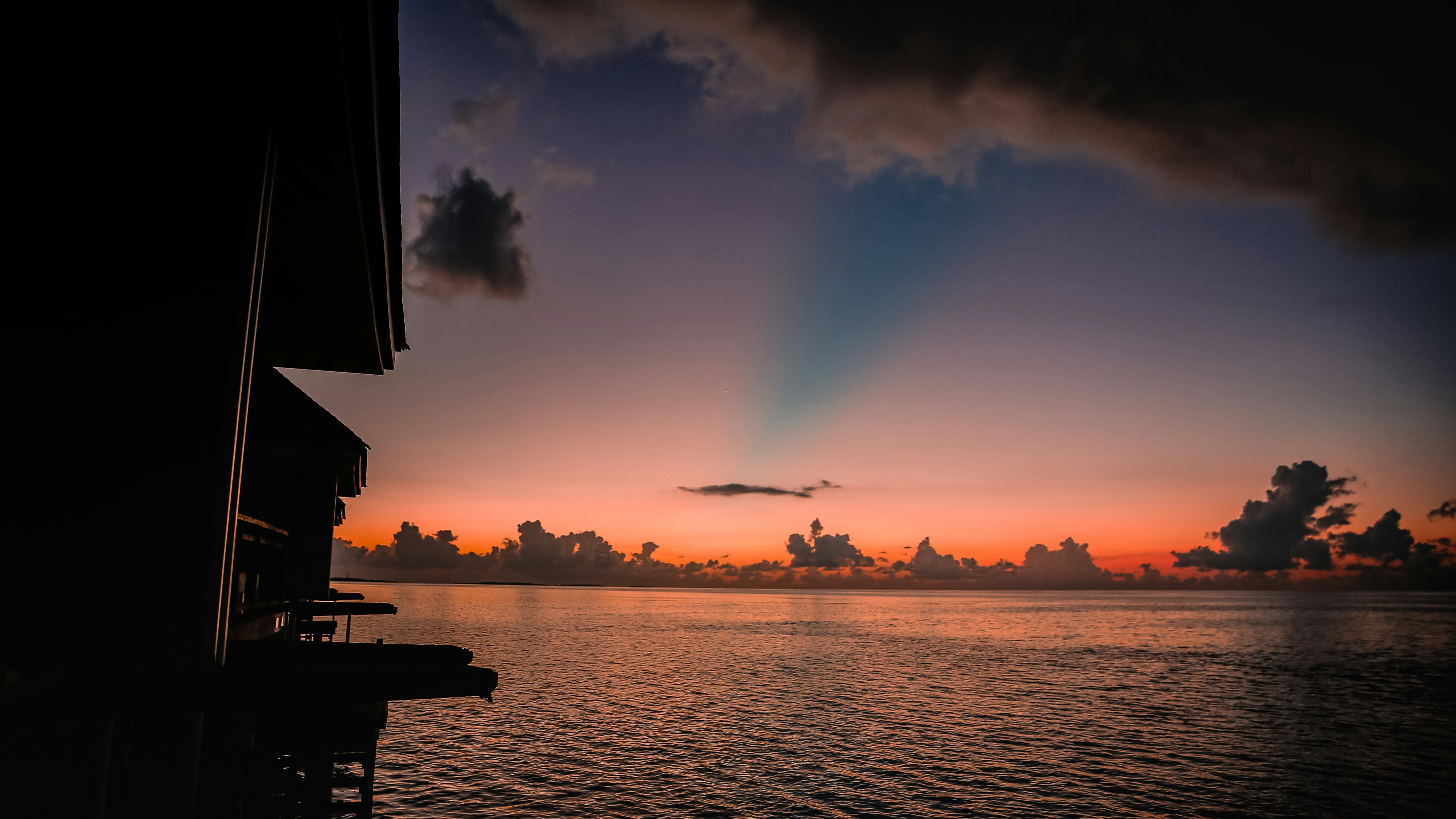 Crepuscular Beacon Over a Quiet Sea