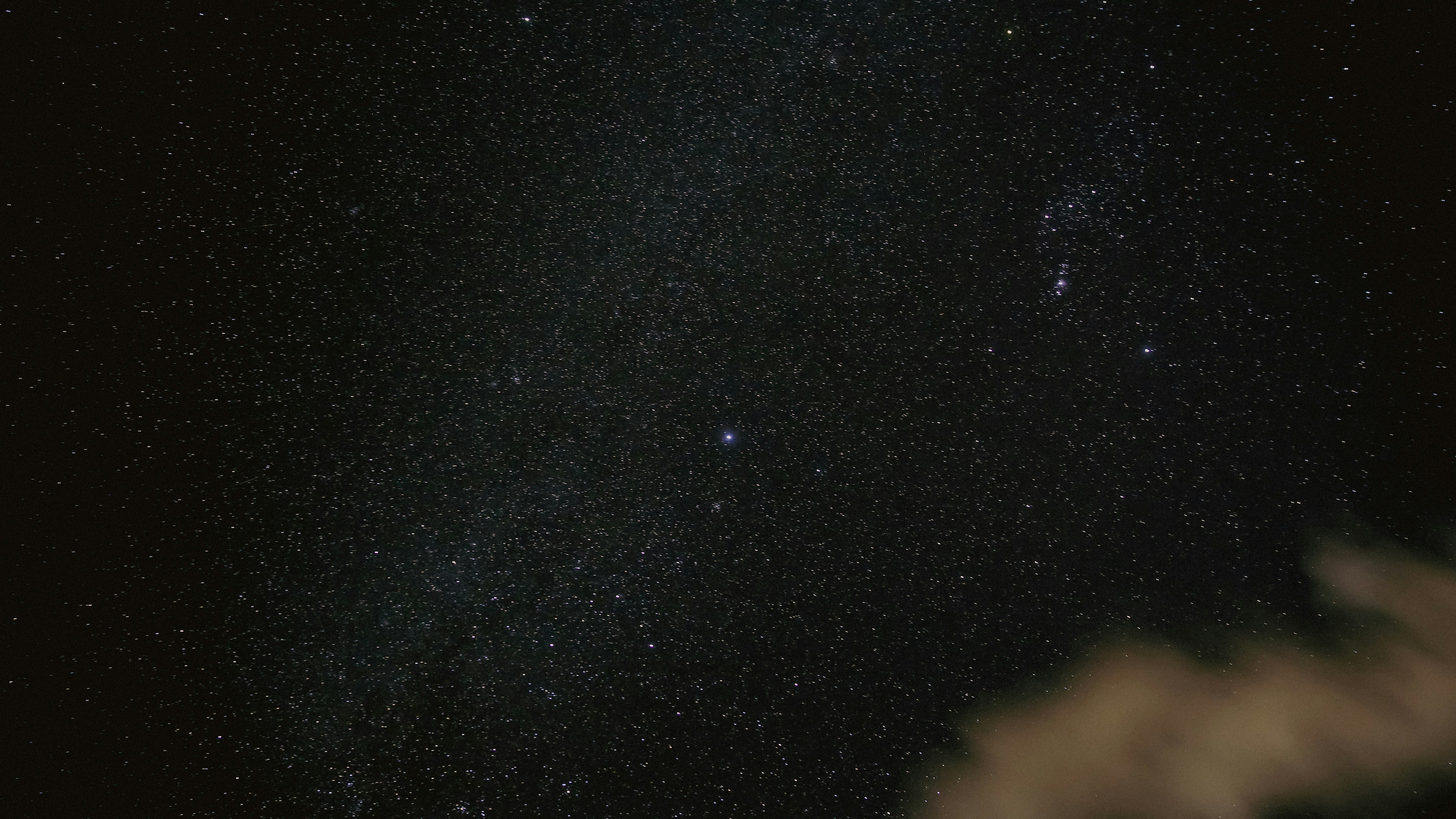 Silent Nebulae: A Clear Night Sky Above the Distant Clouds