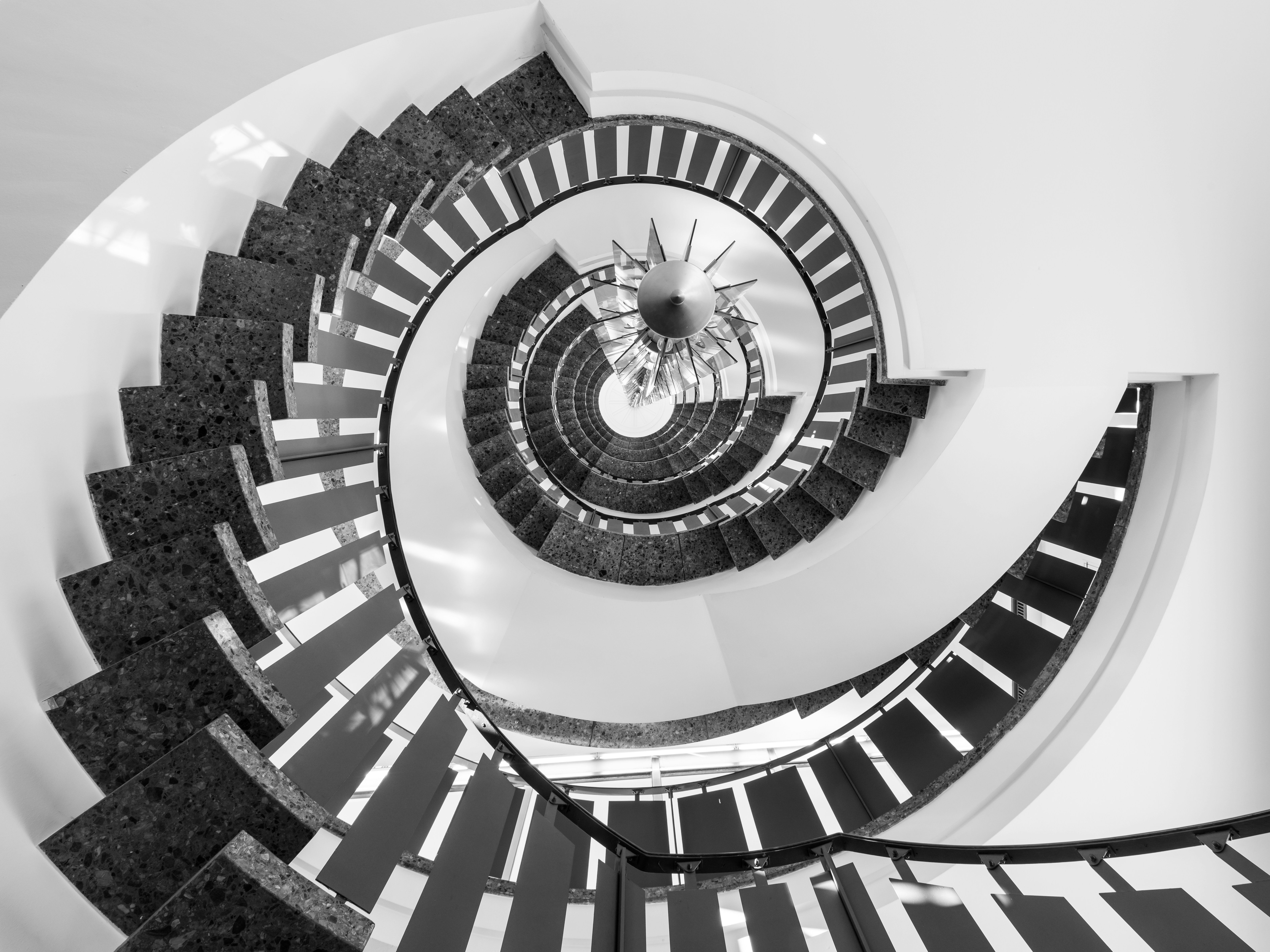 Spiral Descent: A Monochrome Staircase Carved by Light